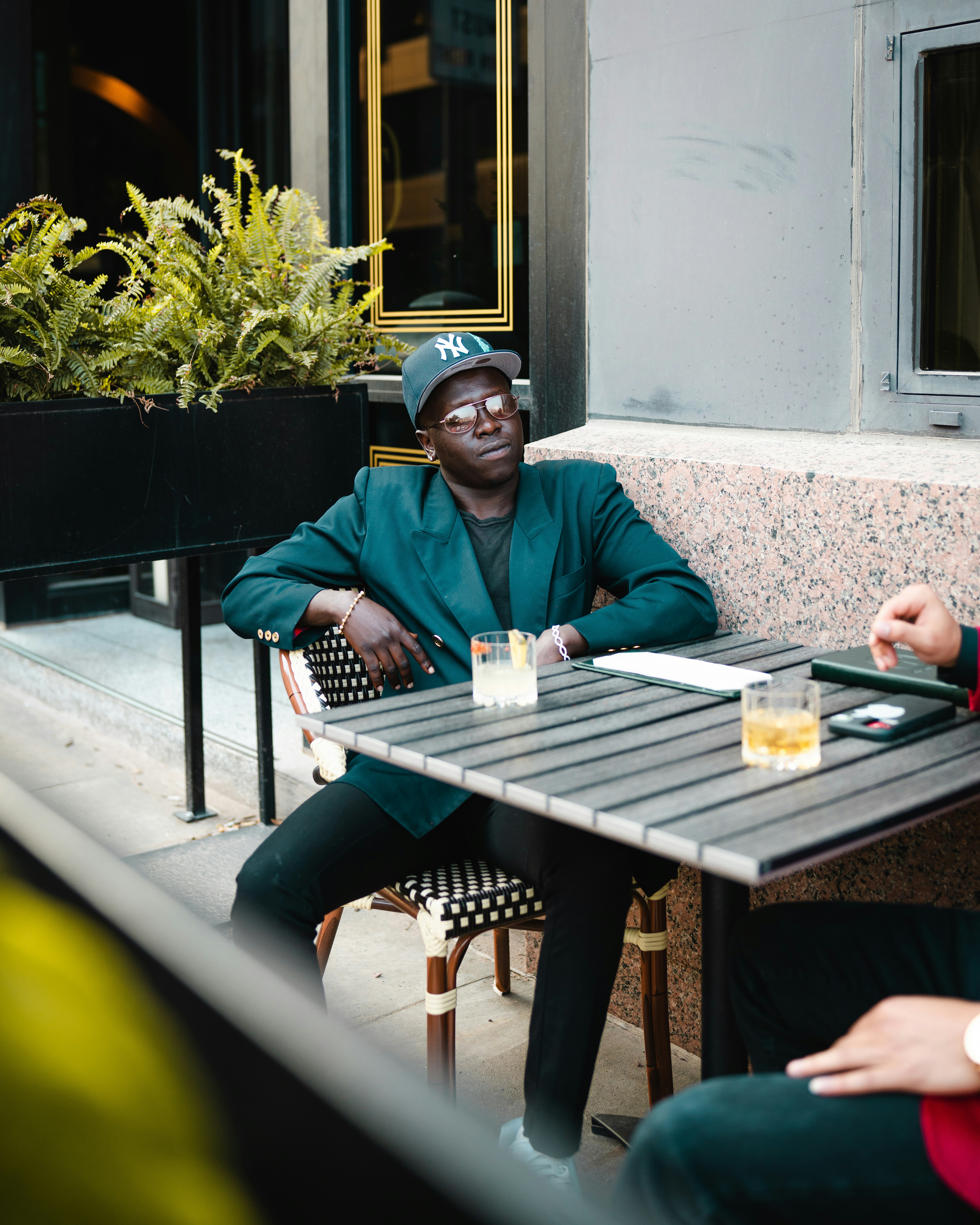 Teal Blazer Confidence at a Sunlit Sidewalk Café