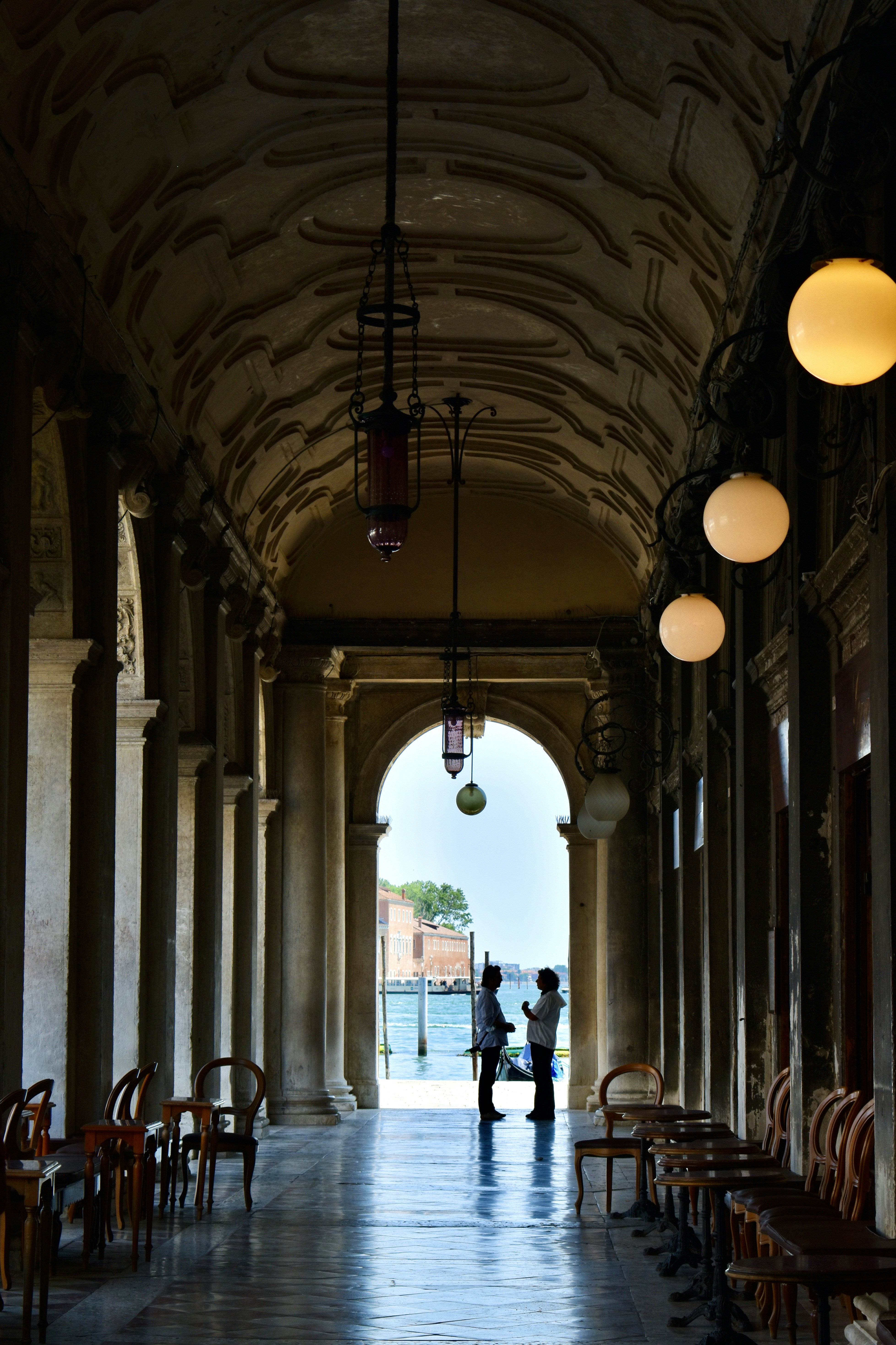 Threshold to the Waterfront: Lantern-lit Corridor and Silhouettes