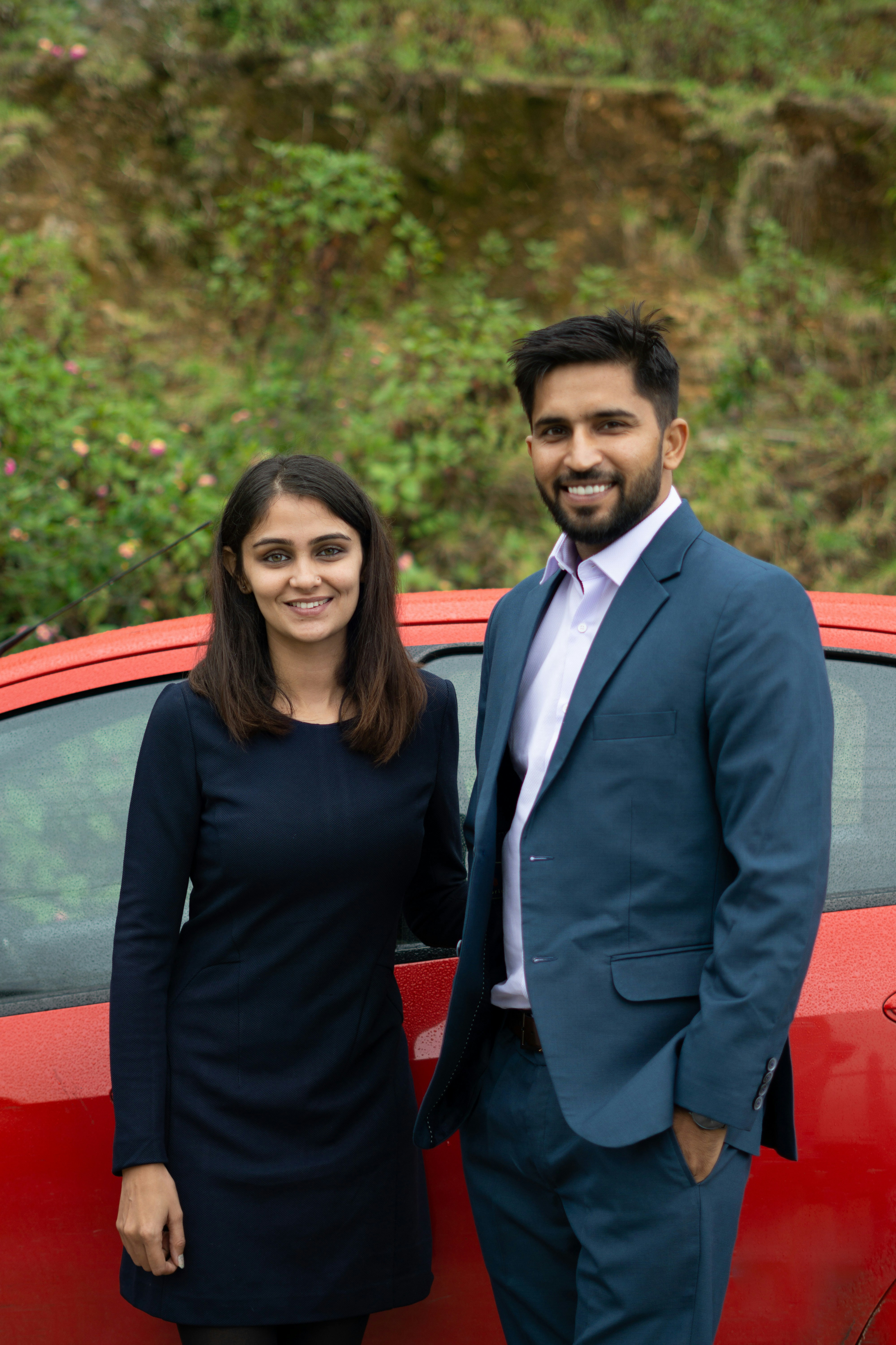 Crimson Car, Deep Navy: A Polished Portrait of a Couple