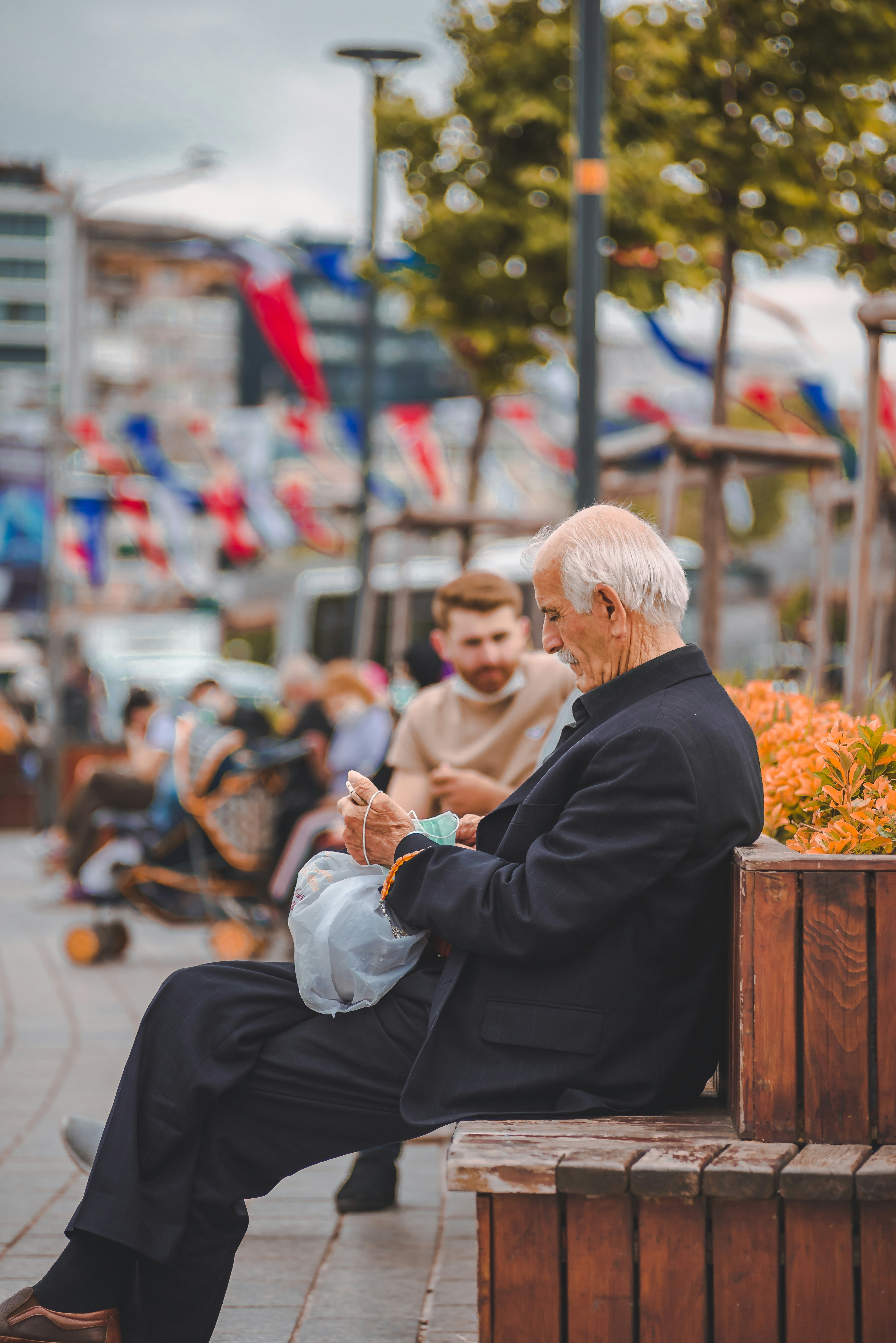 Old Man in a Black Coat, Lost in a City Parade