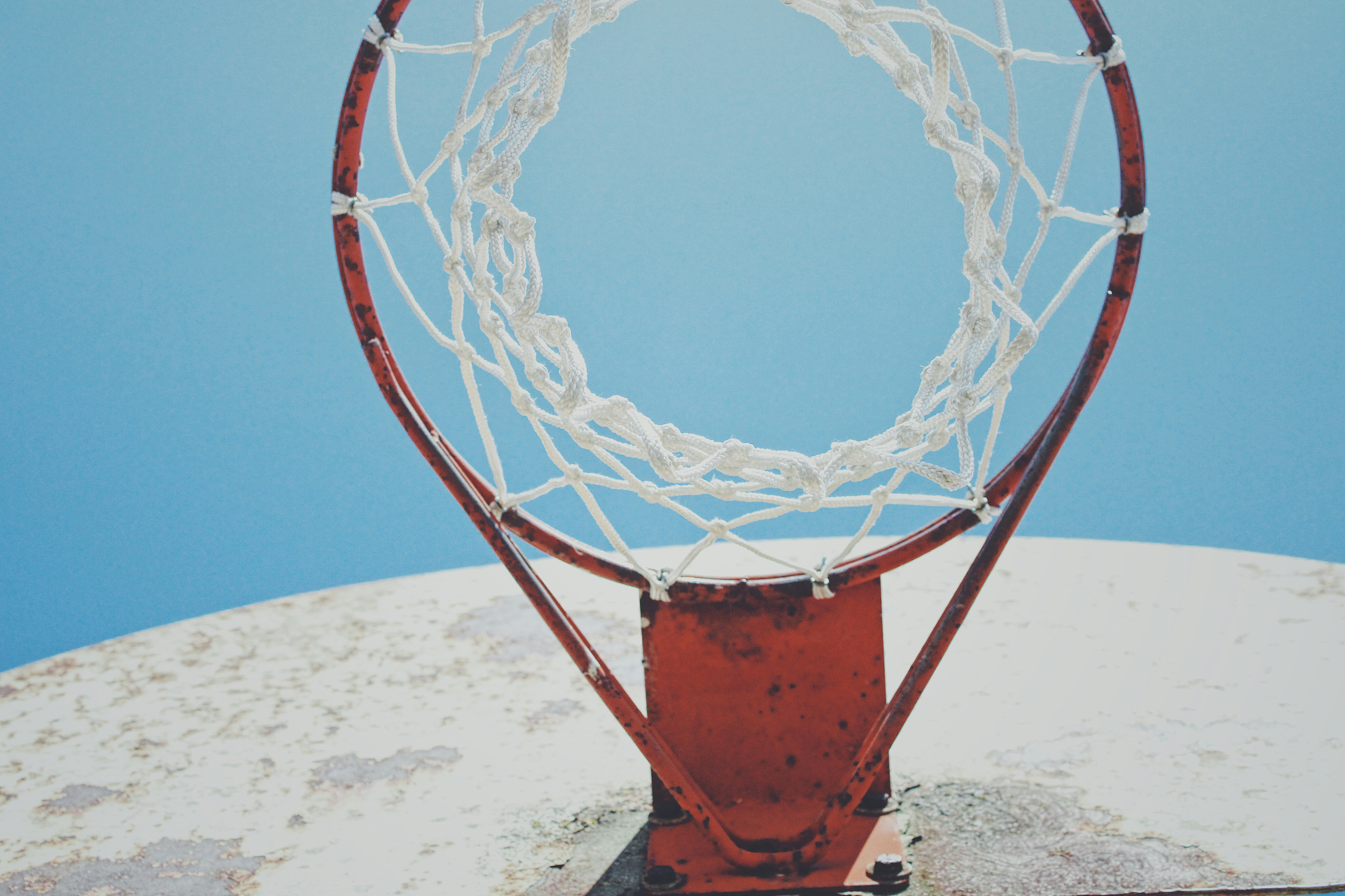 Red basketball hoop on white sand during daytime photo – Free ...
