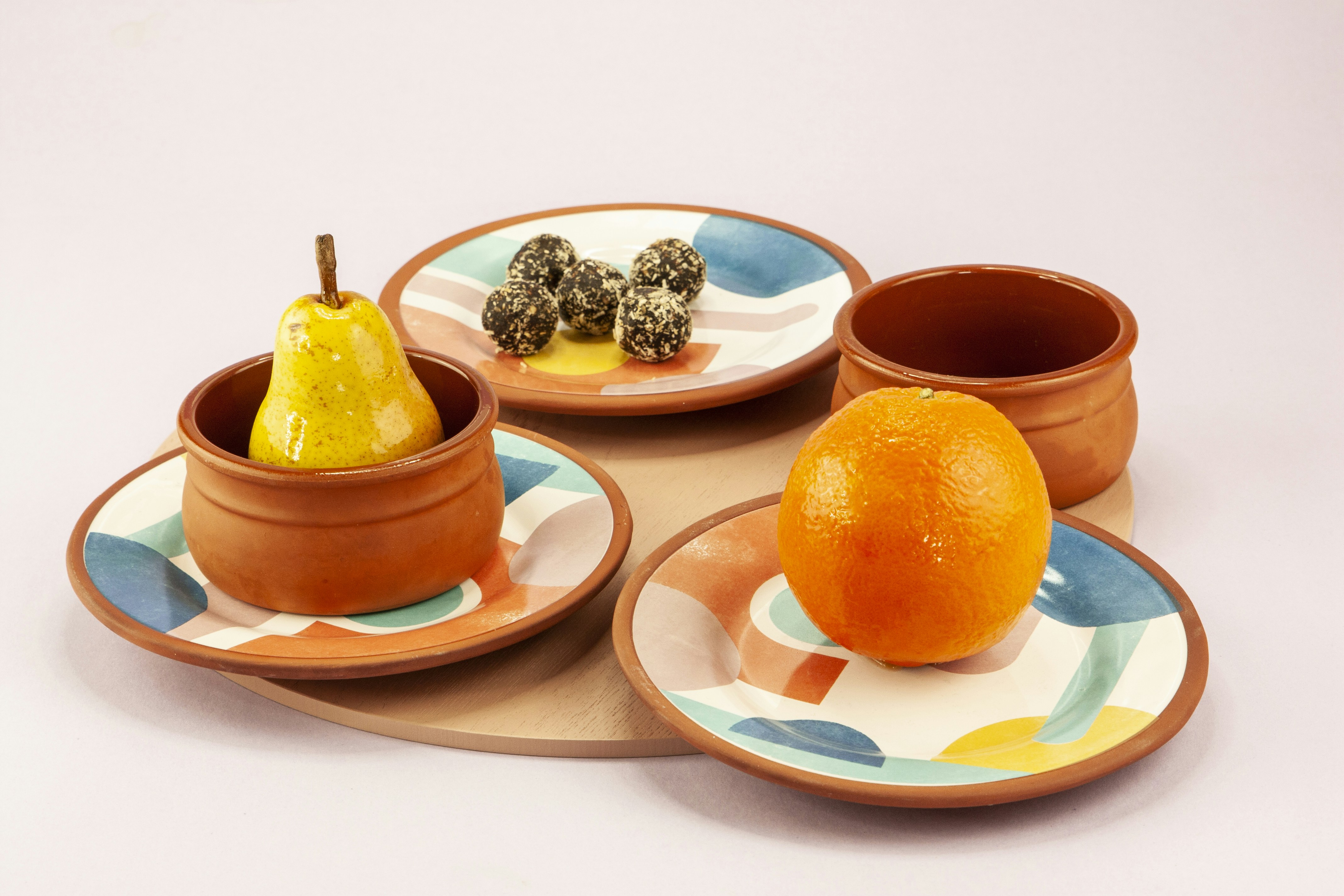 Colorful Still Life: Ceramics, Fruit, and Treats on Painted Plates