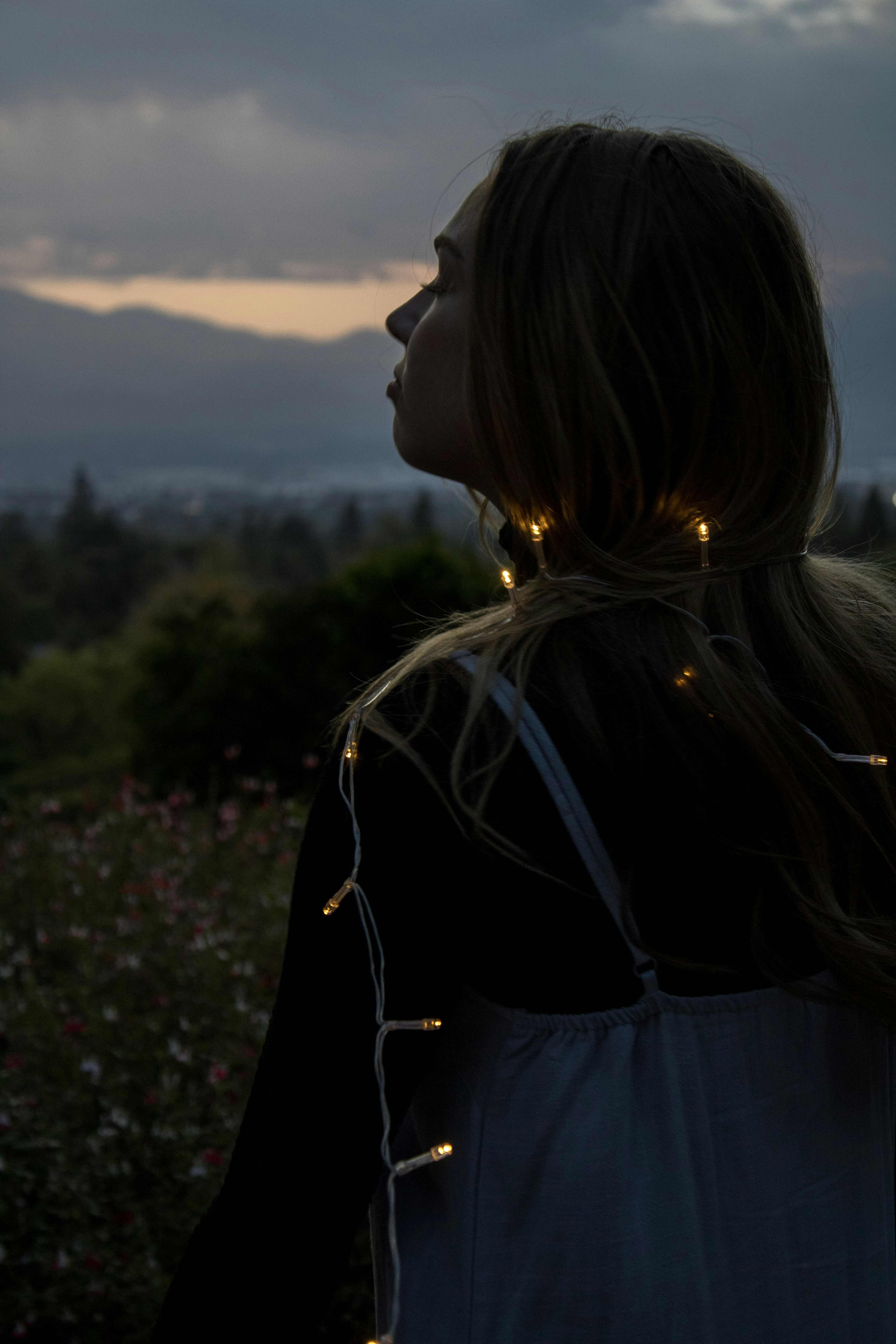 Dusk Portrait: A Halo of Fairy Lights Framing a Quiet Silhouette