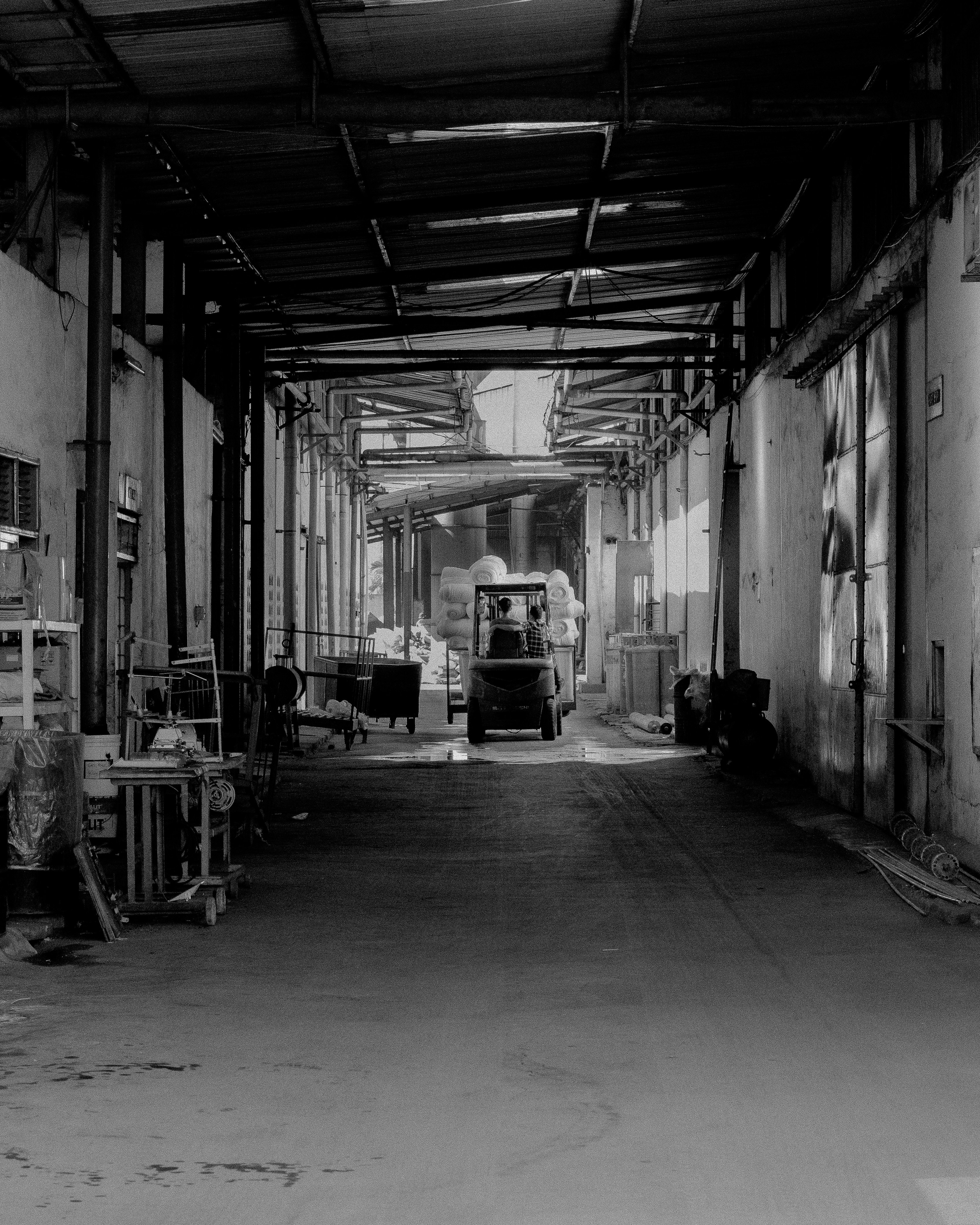 a worker driving forklift carrying a cotton textile