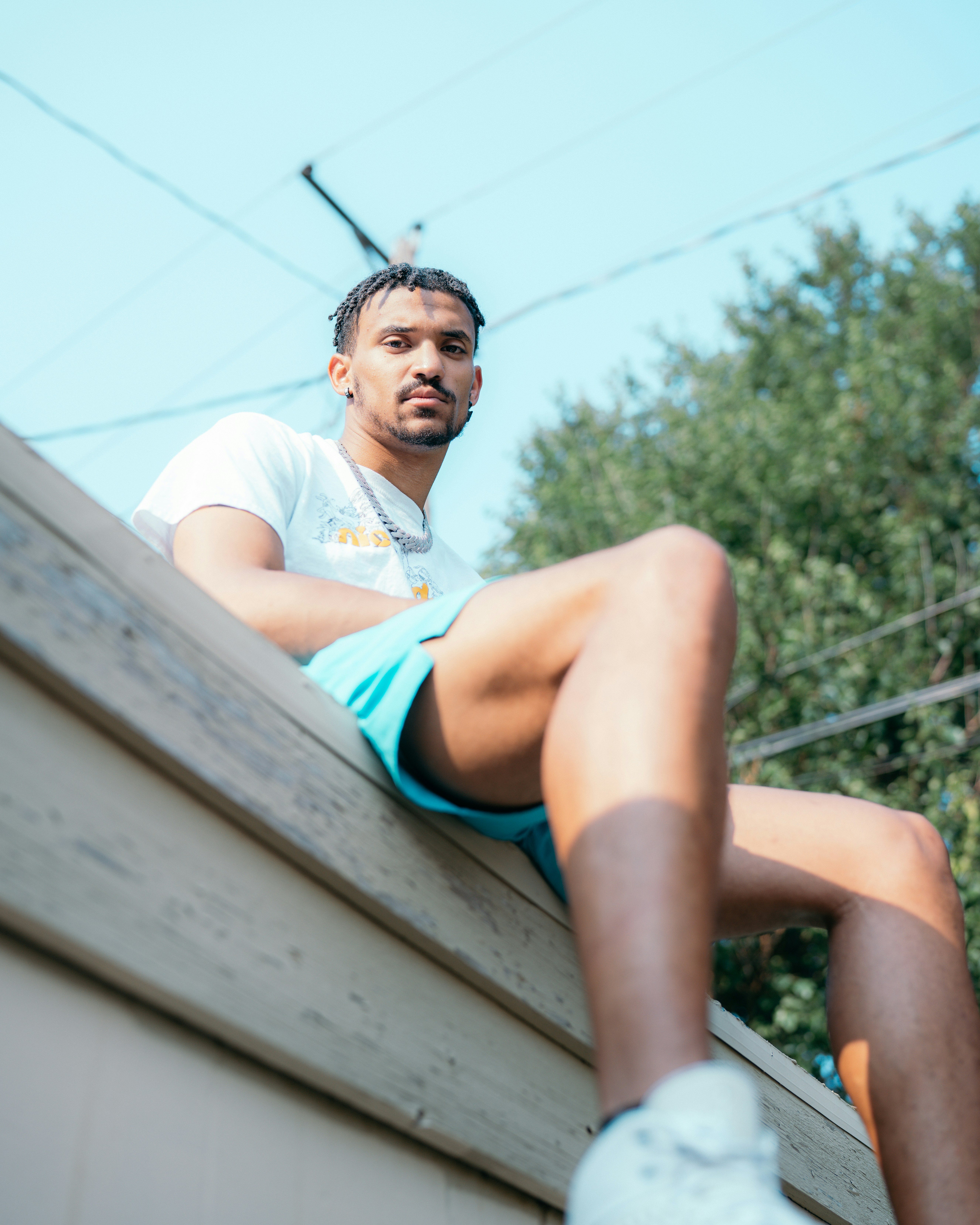 Rooftop Gaze: A Low-Angle Portrait in Bright Daylight