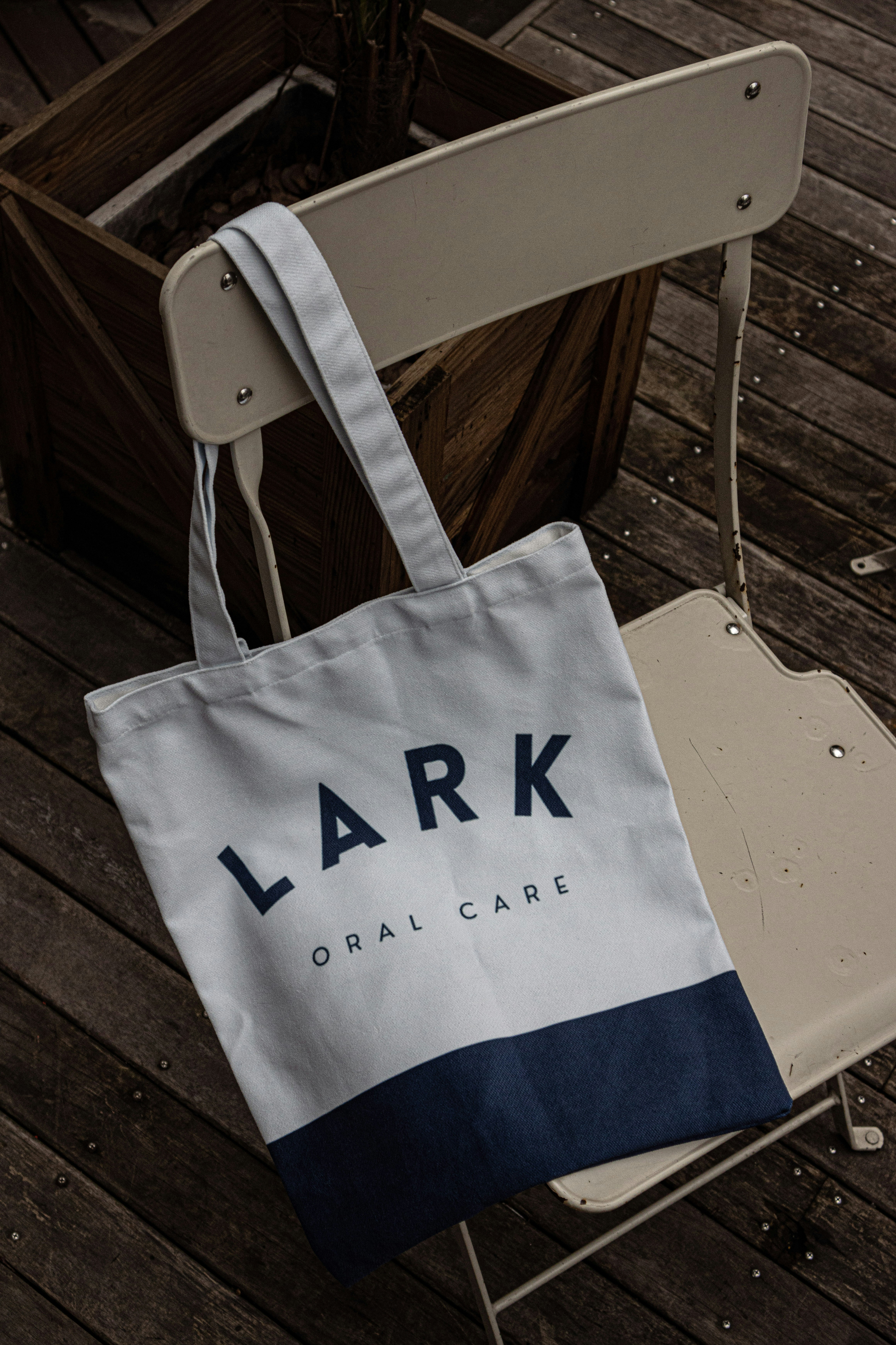 Lark Oral Care tote bag on chair. | white and blue tote bag