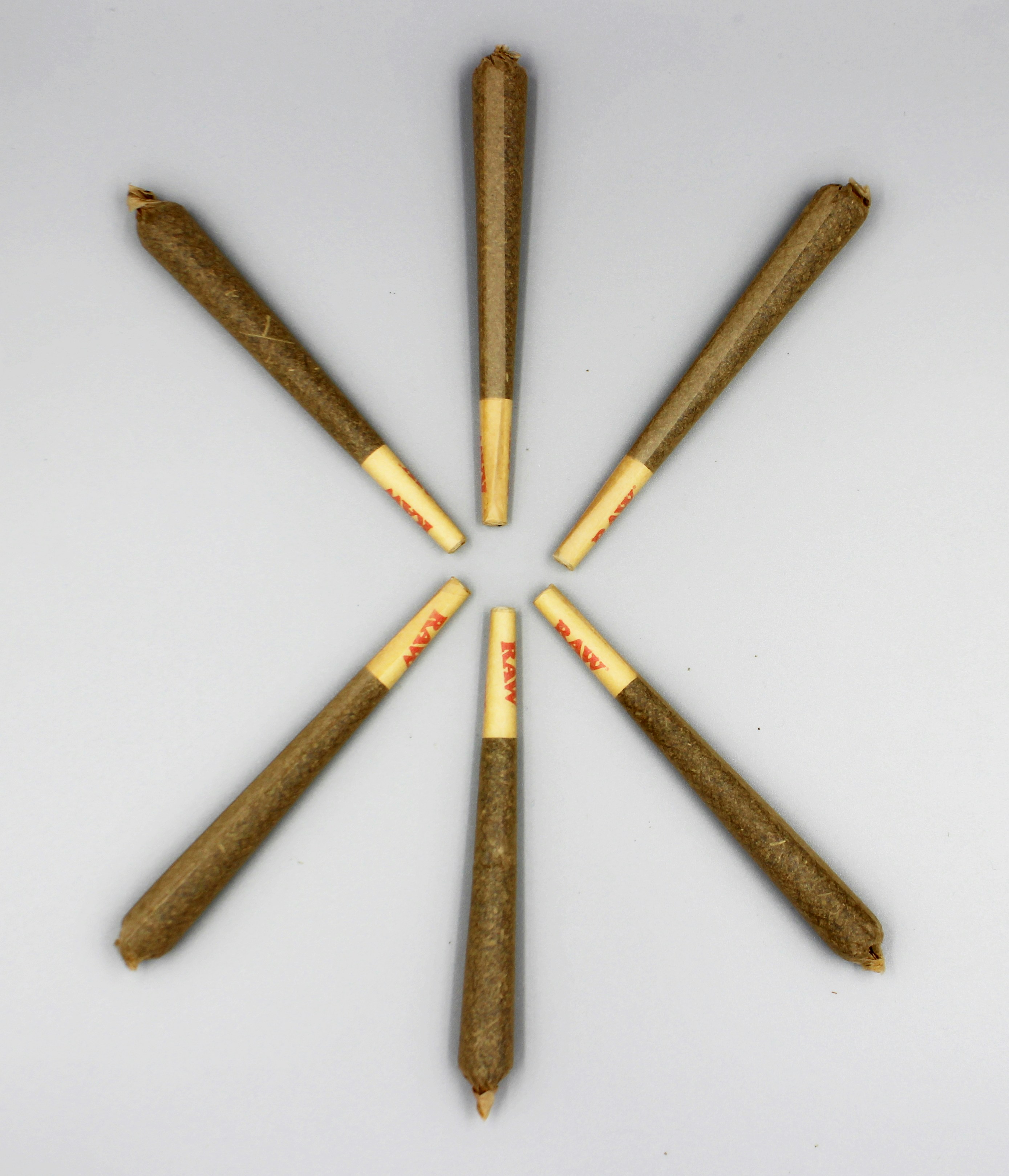 Six herbal cones arranged in a star pattern on a neutral background.