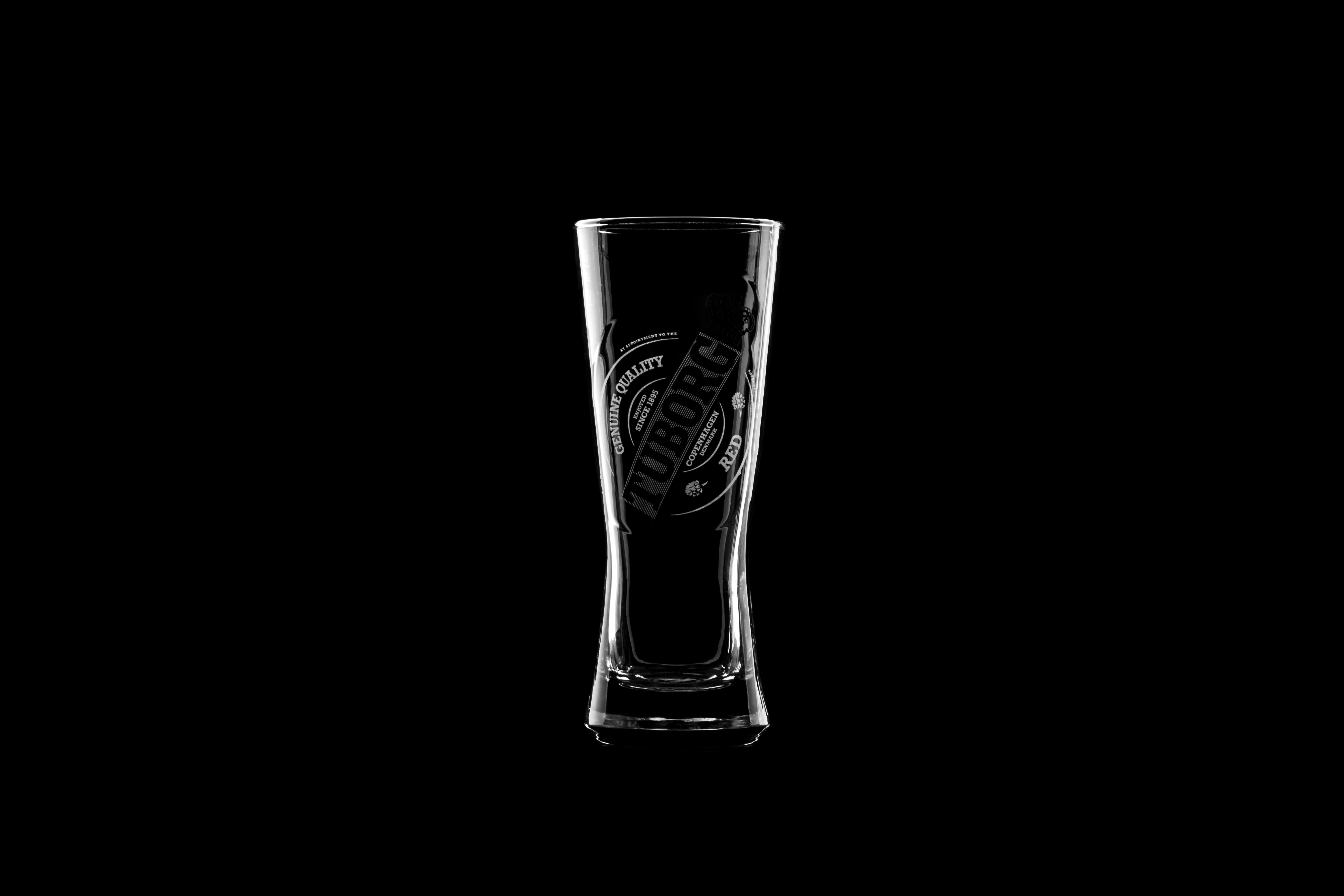 Midnight Glass: A solitary pilsner on a void-black stage