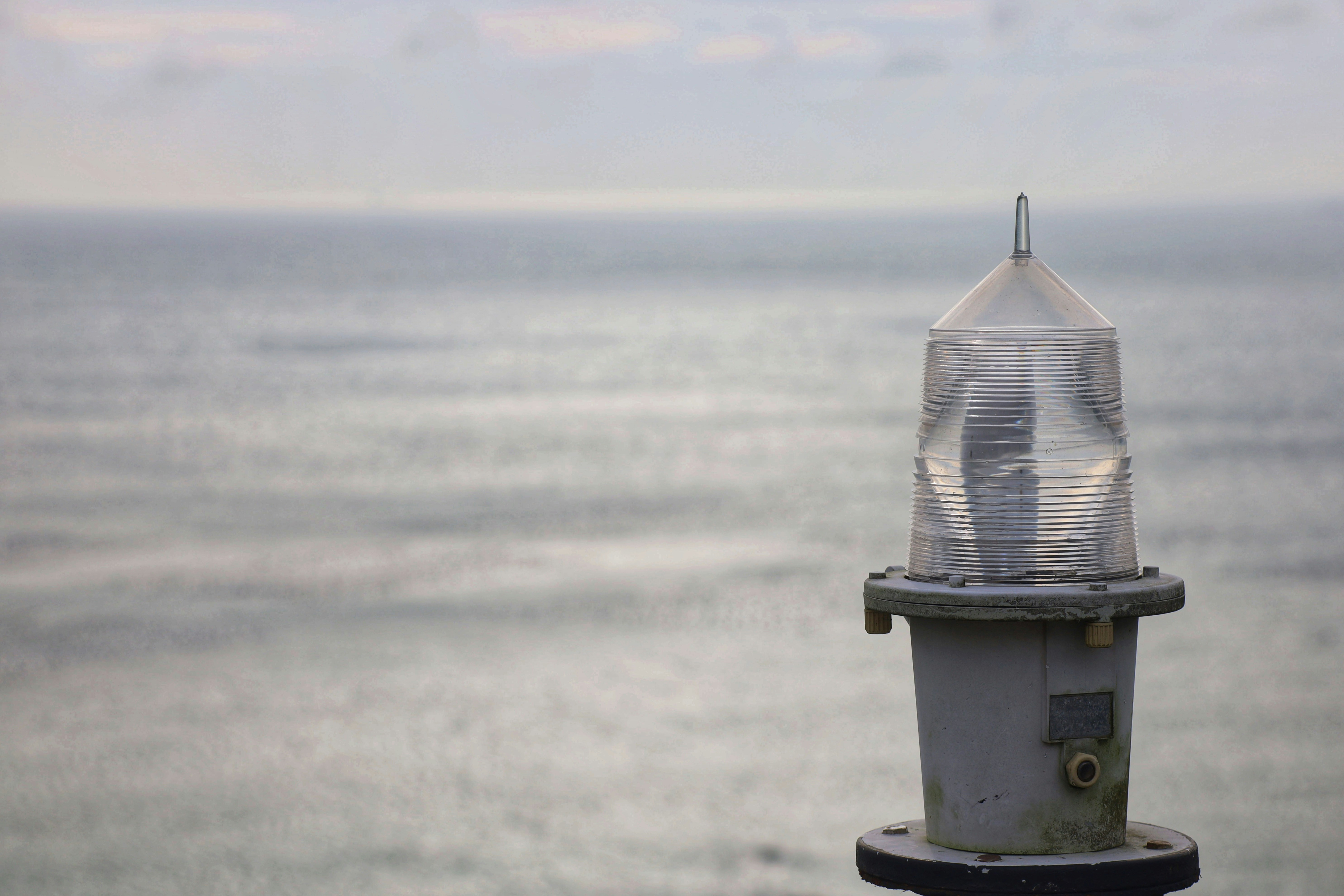 Weathered Glass Lantern at the Edge of a Quiet Sea