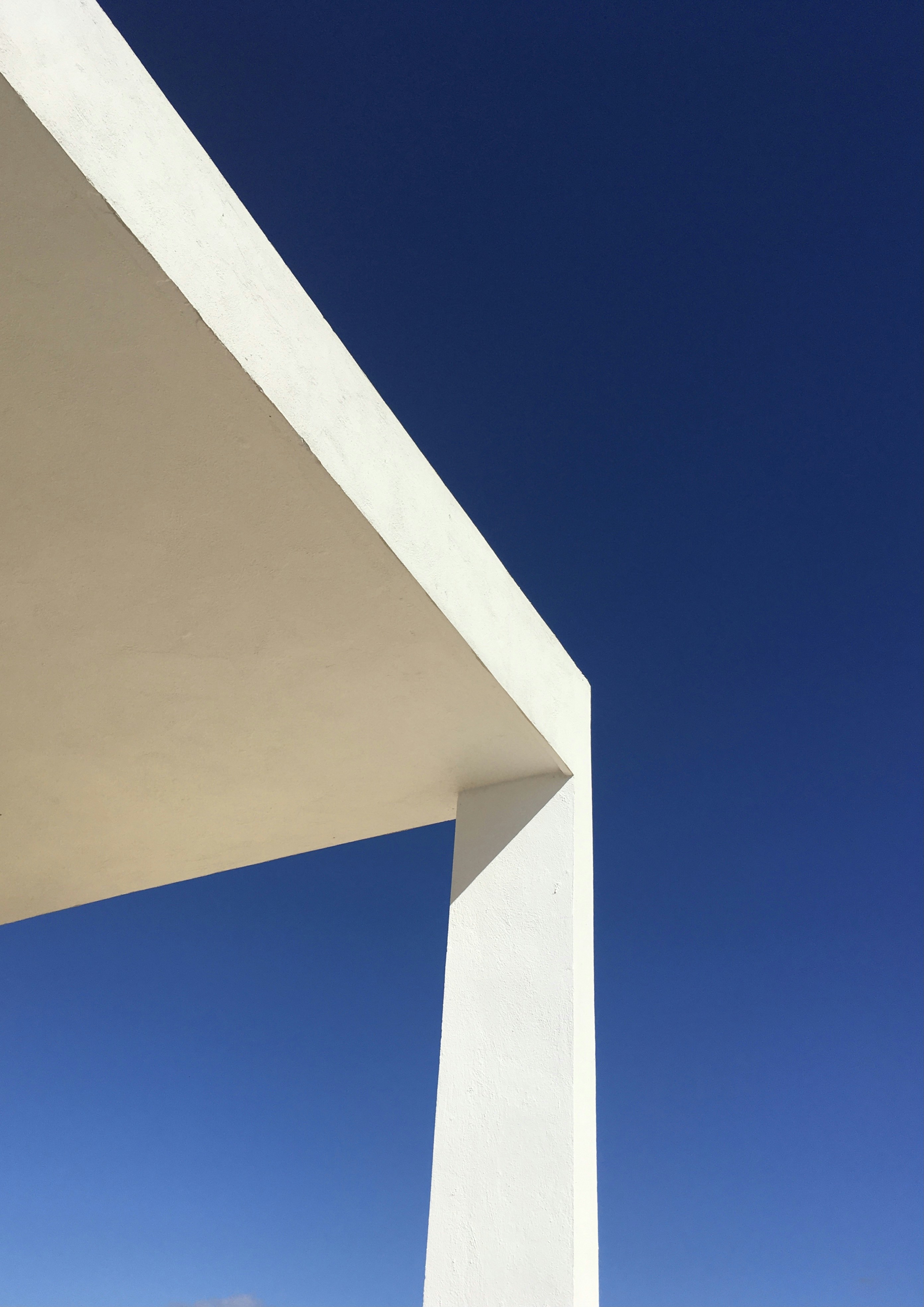 White architectural structure contrasts with a deep blue sky.