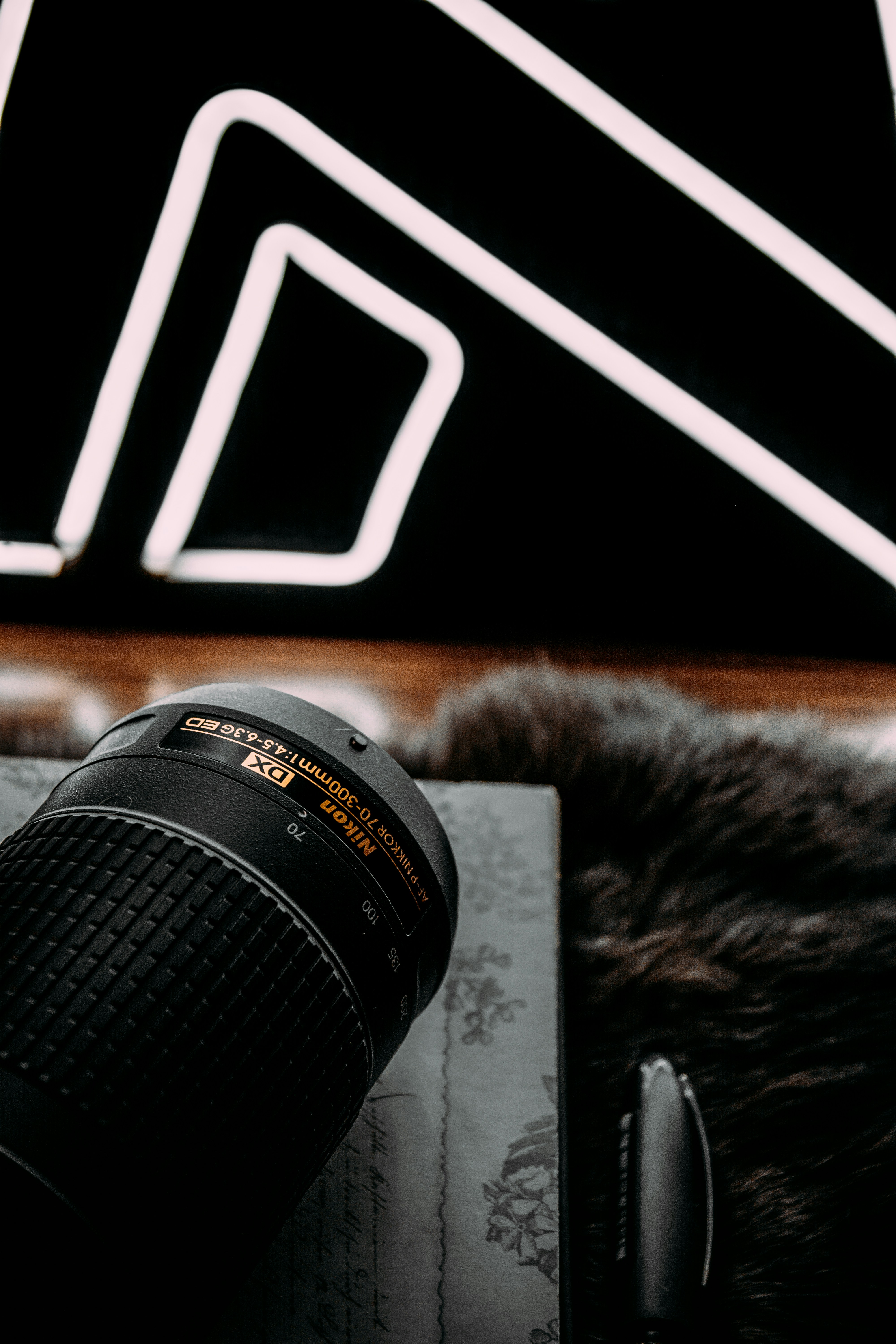 Neon Geometry Cradled by a Quiet Nikon DX Kit Lens