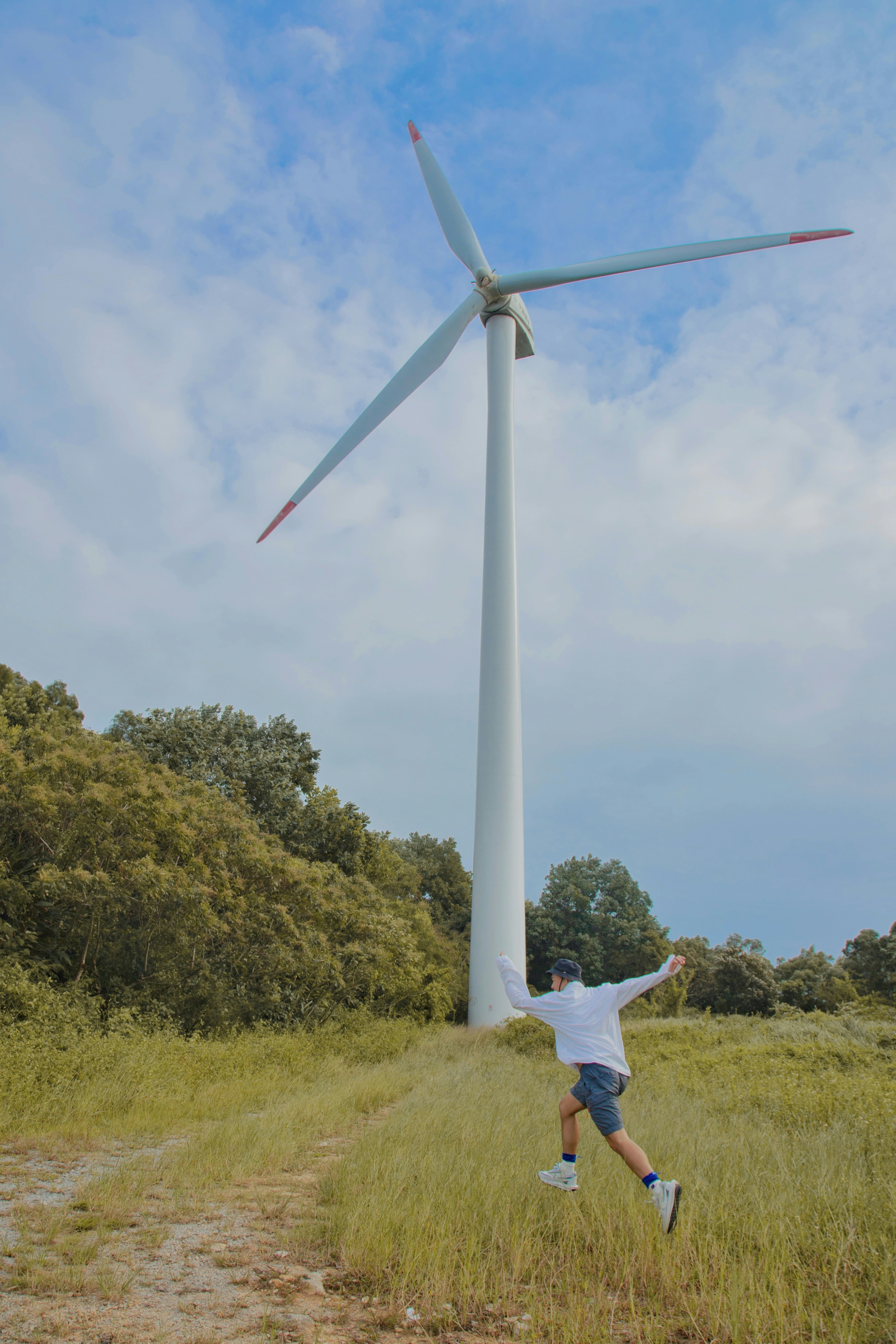 A man running in front of a wind turbine photo – Free Human Image on ...