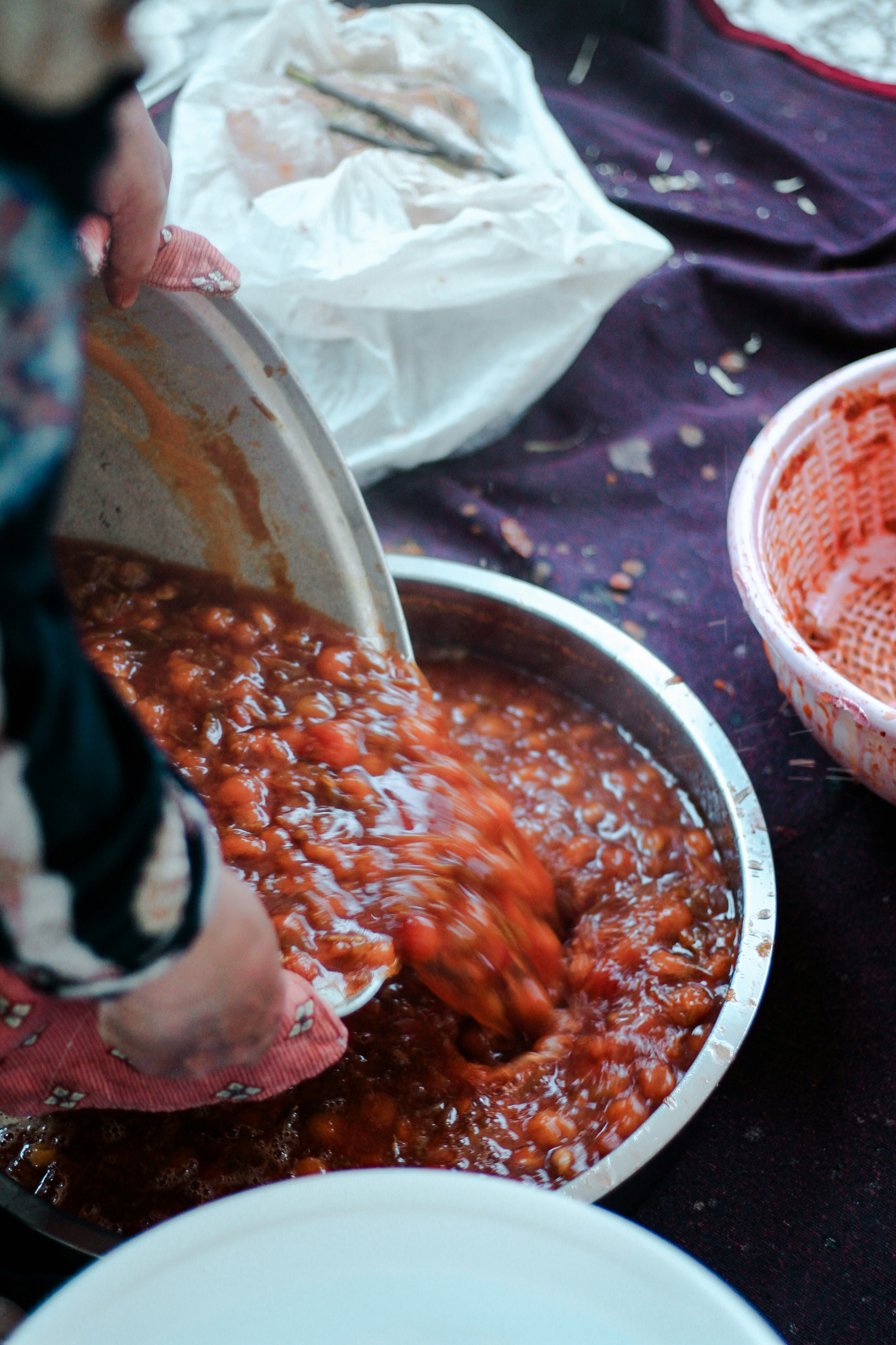 Hands Stirred in a Pot: A Busy Moment of Sauce Preparation