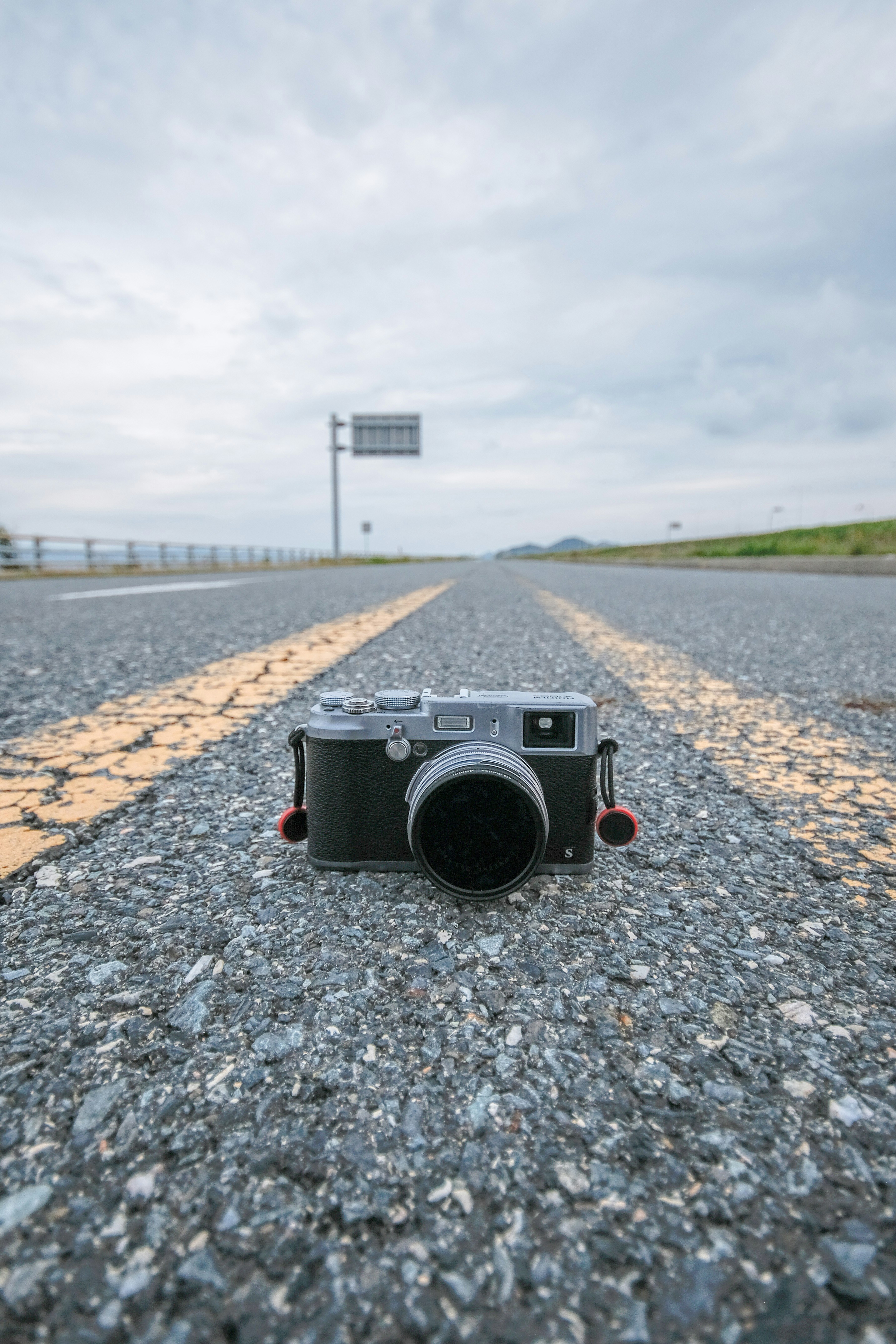 black and silver camera on road during daytime