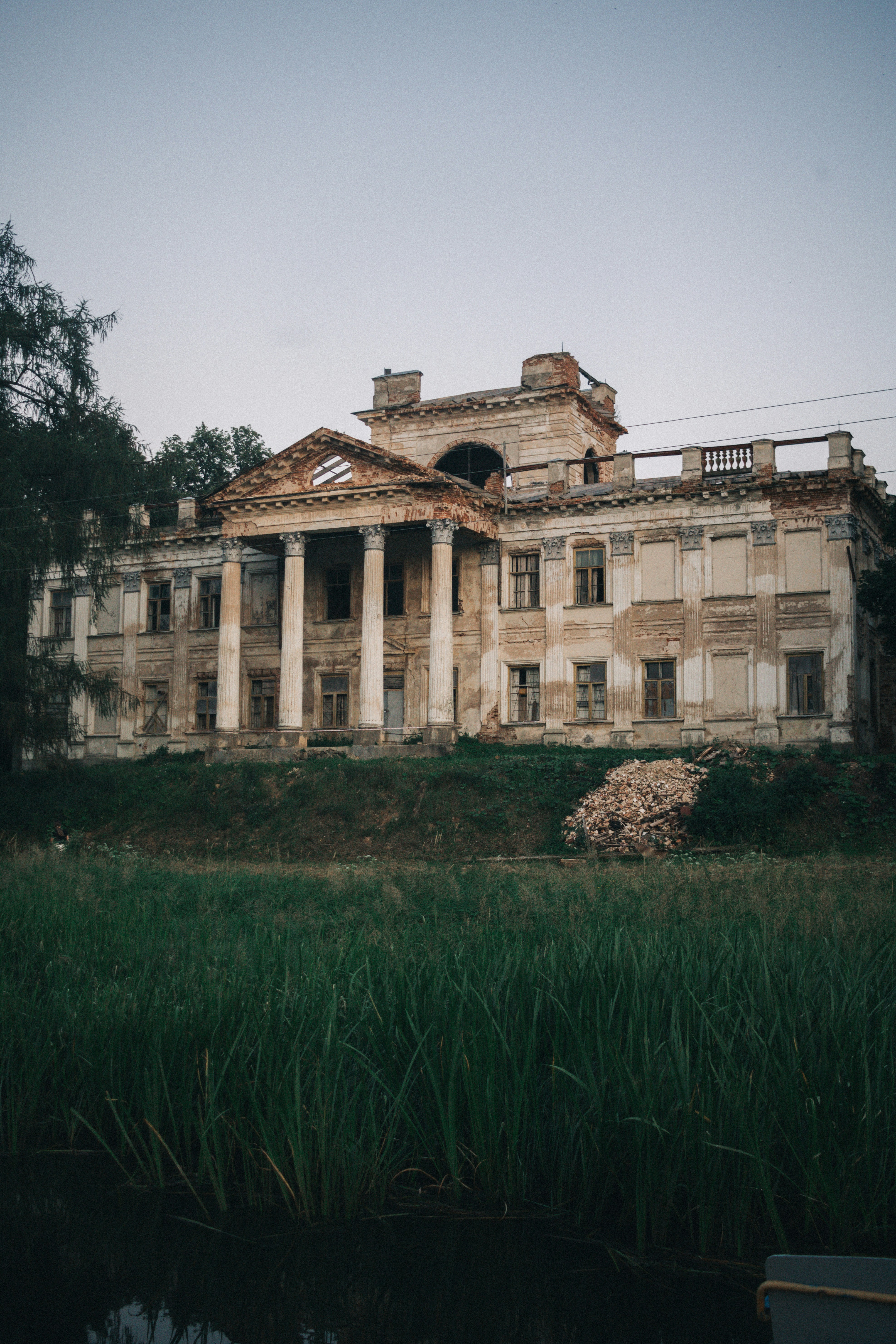 Weathered Colonnade: The Ruined Manor's Silent Grandeur