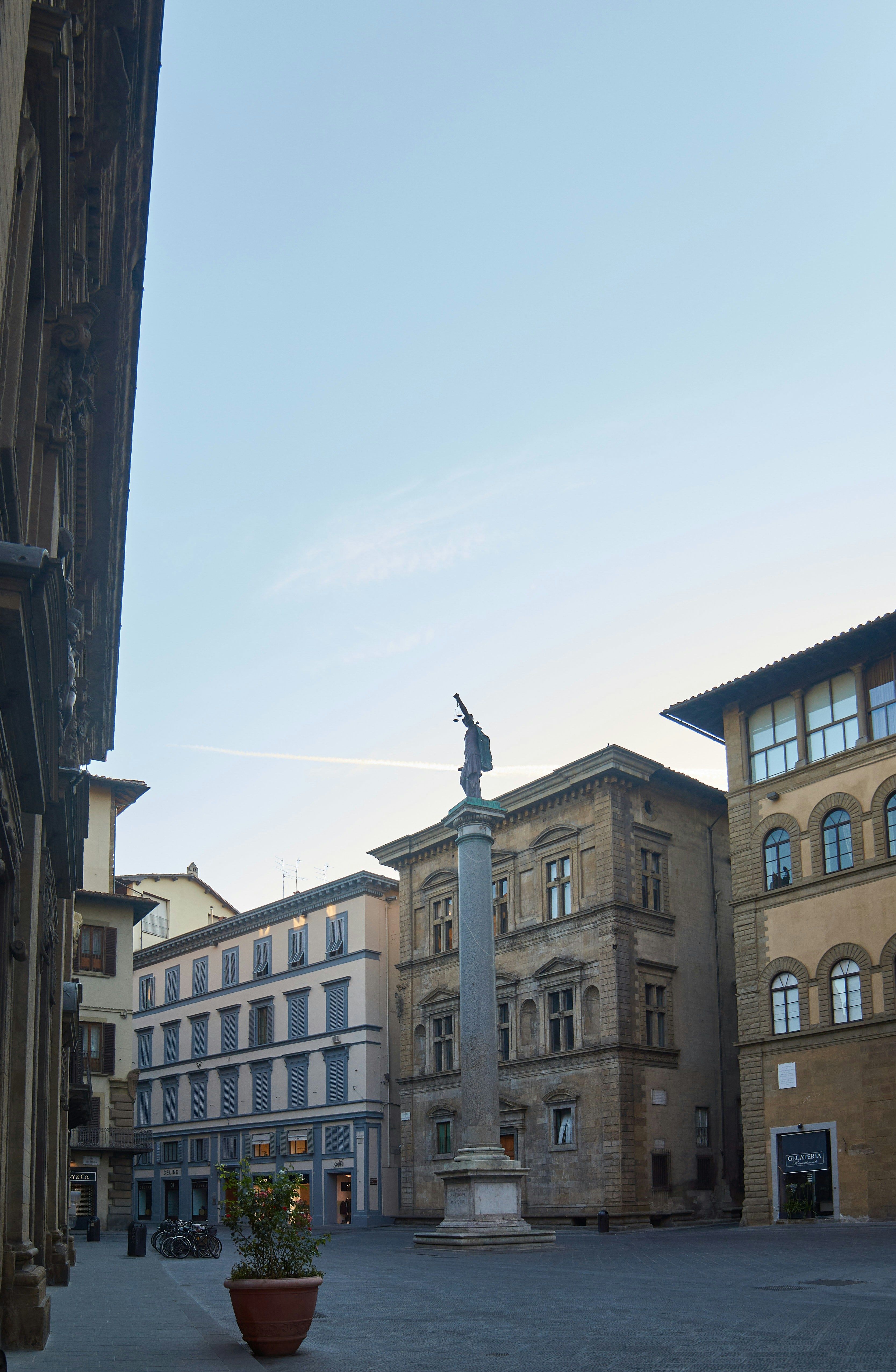 Stone Sentinel on a Sunlit European Piazza