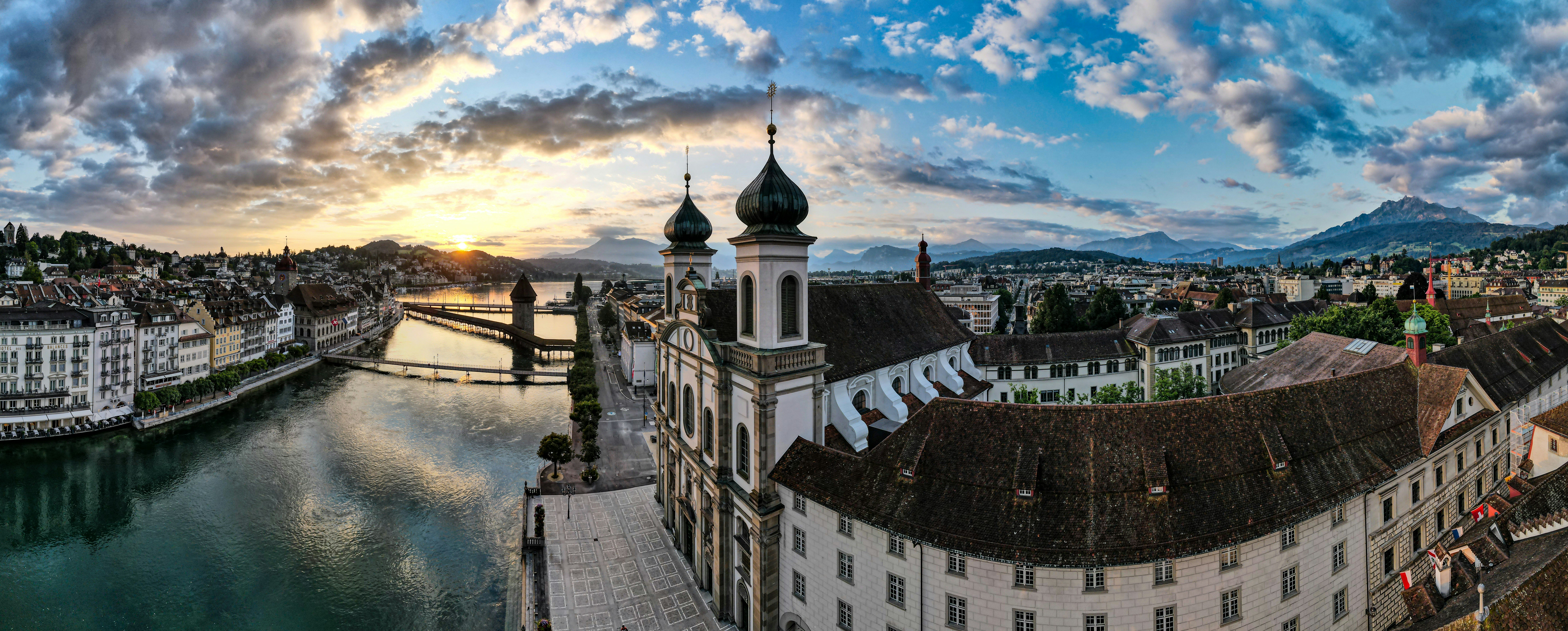 Domed Clock Tower Over the River: A Panoramic Alpine Townscape