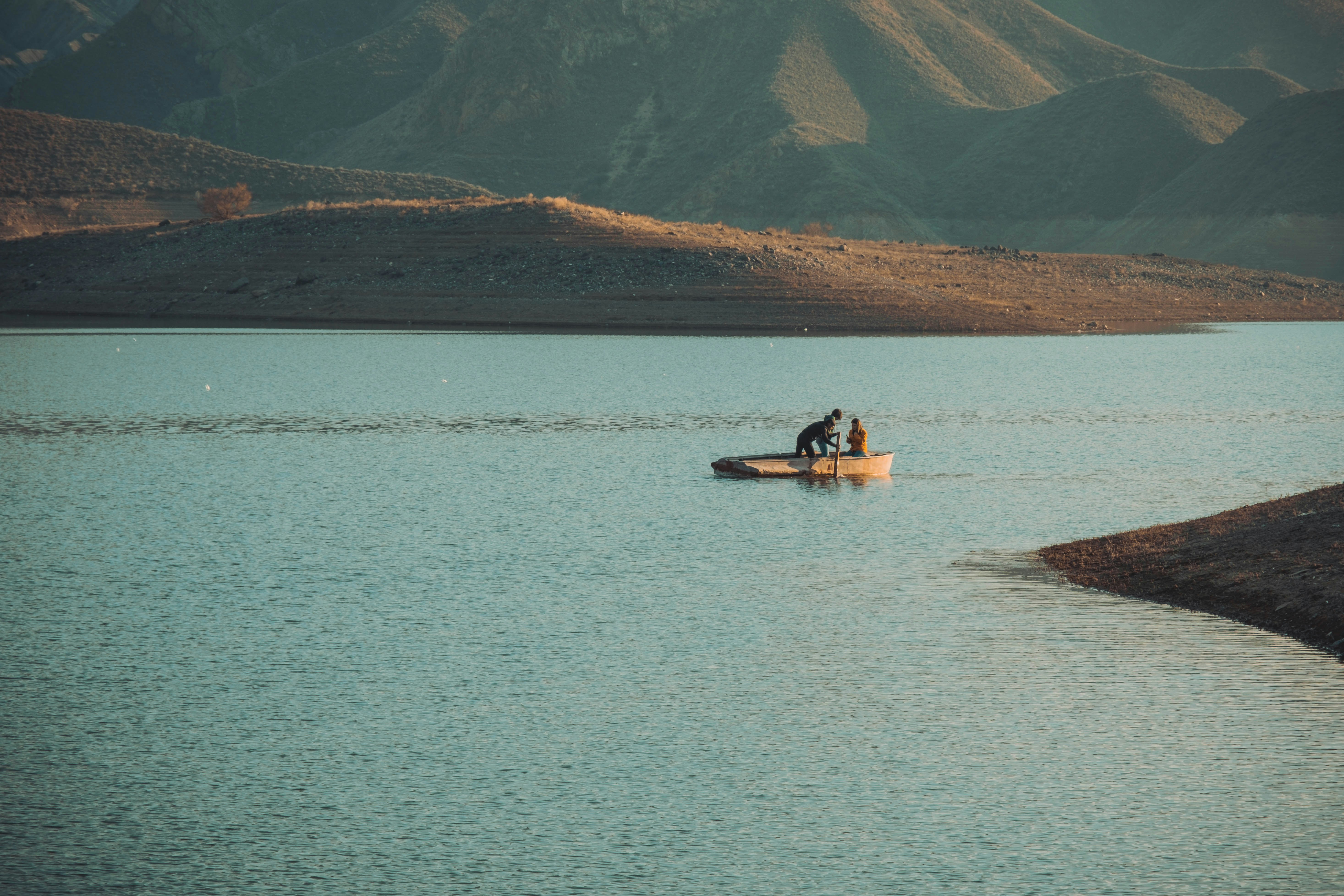 Echoes of Silence: A Lone Boat on a Turquoise Alpine Lake