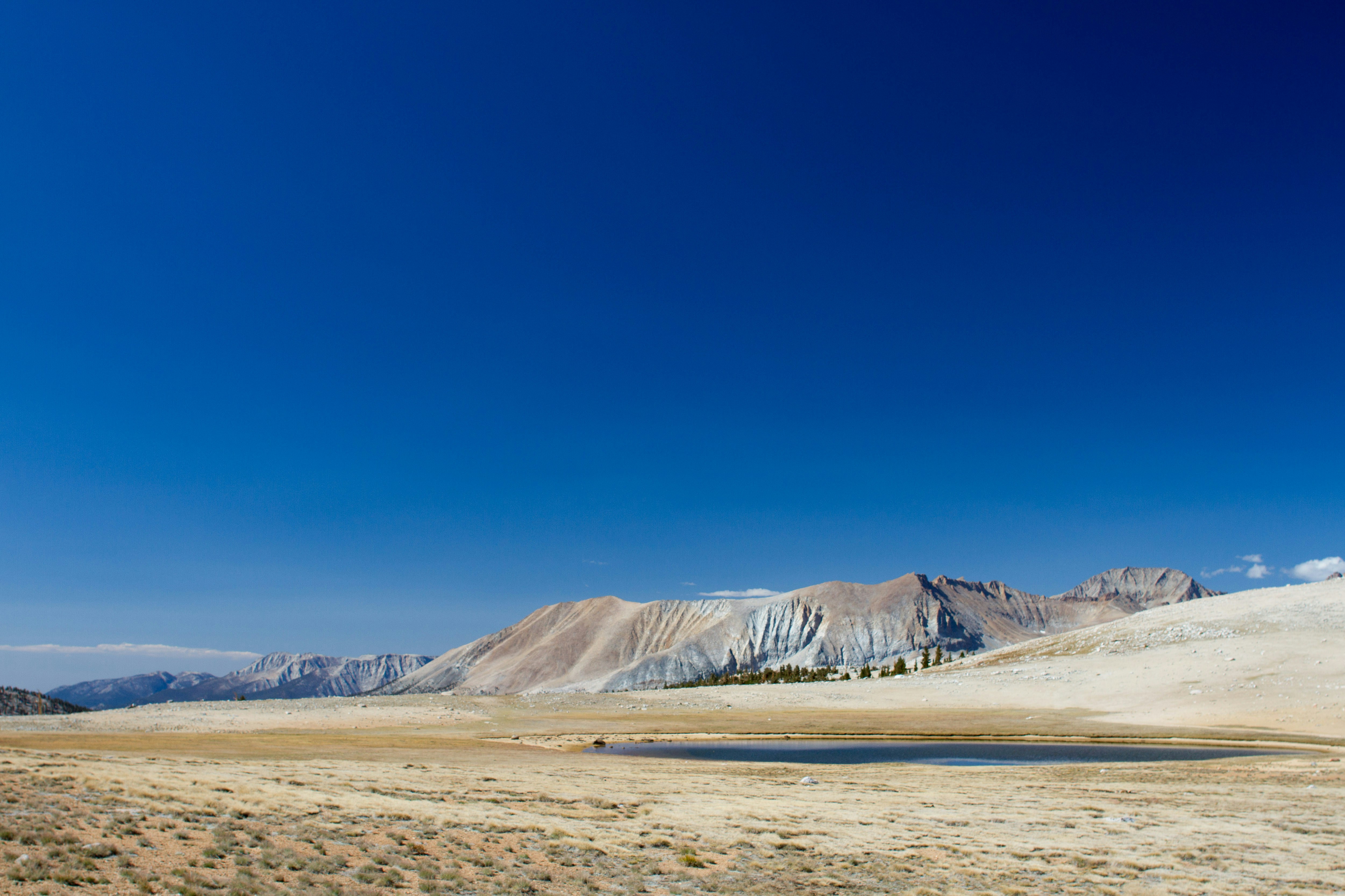 Brown sand field under blue sky during daytime photo – Free Lake Image ...