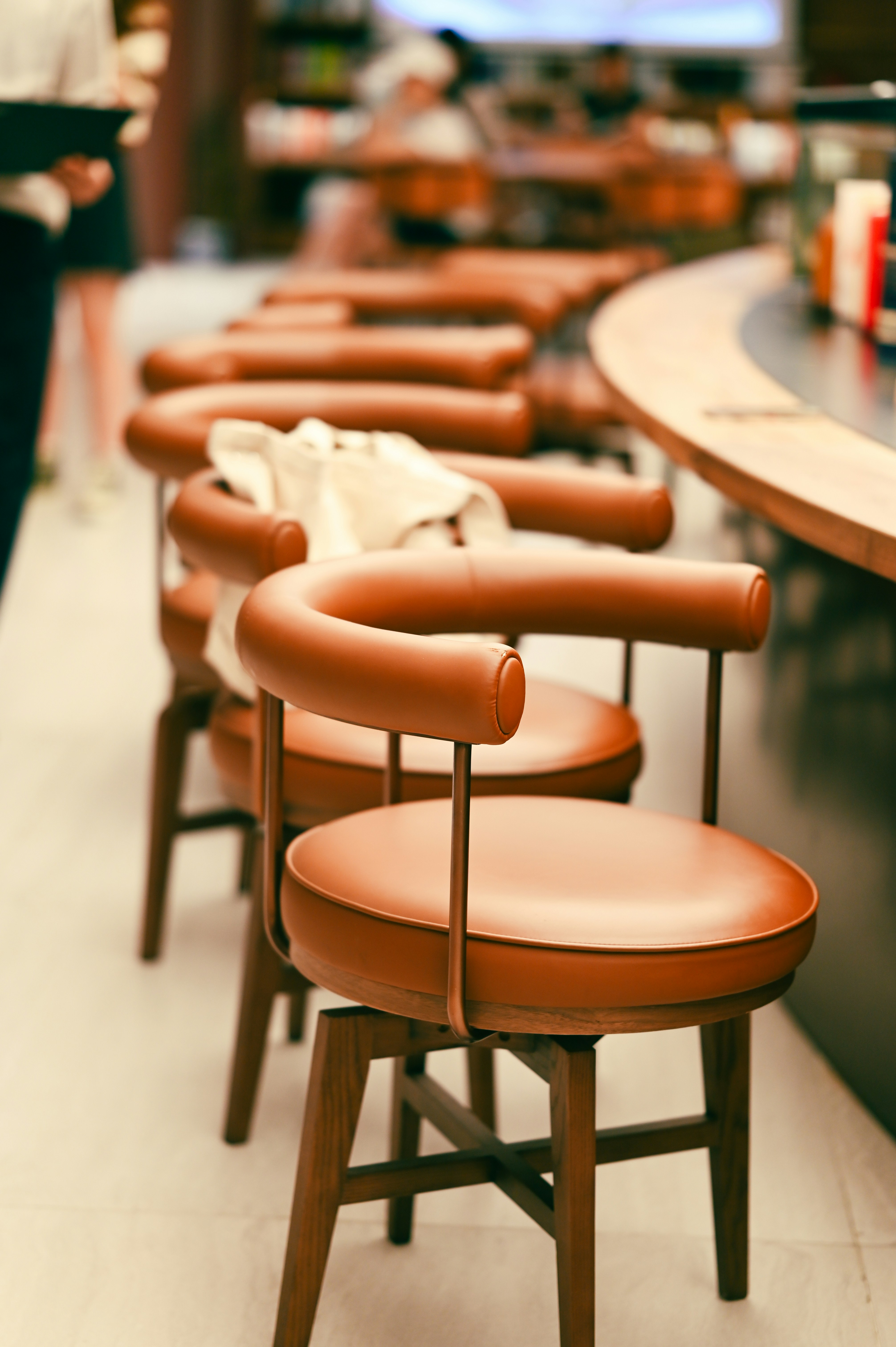 Banquet of Brown: Row of Leather-Bar Stool Highlights in Warm Café Light