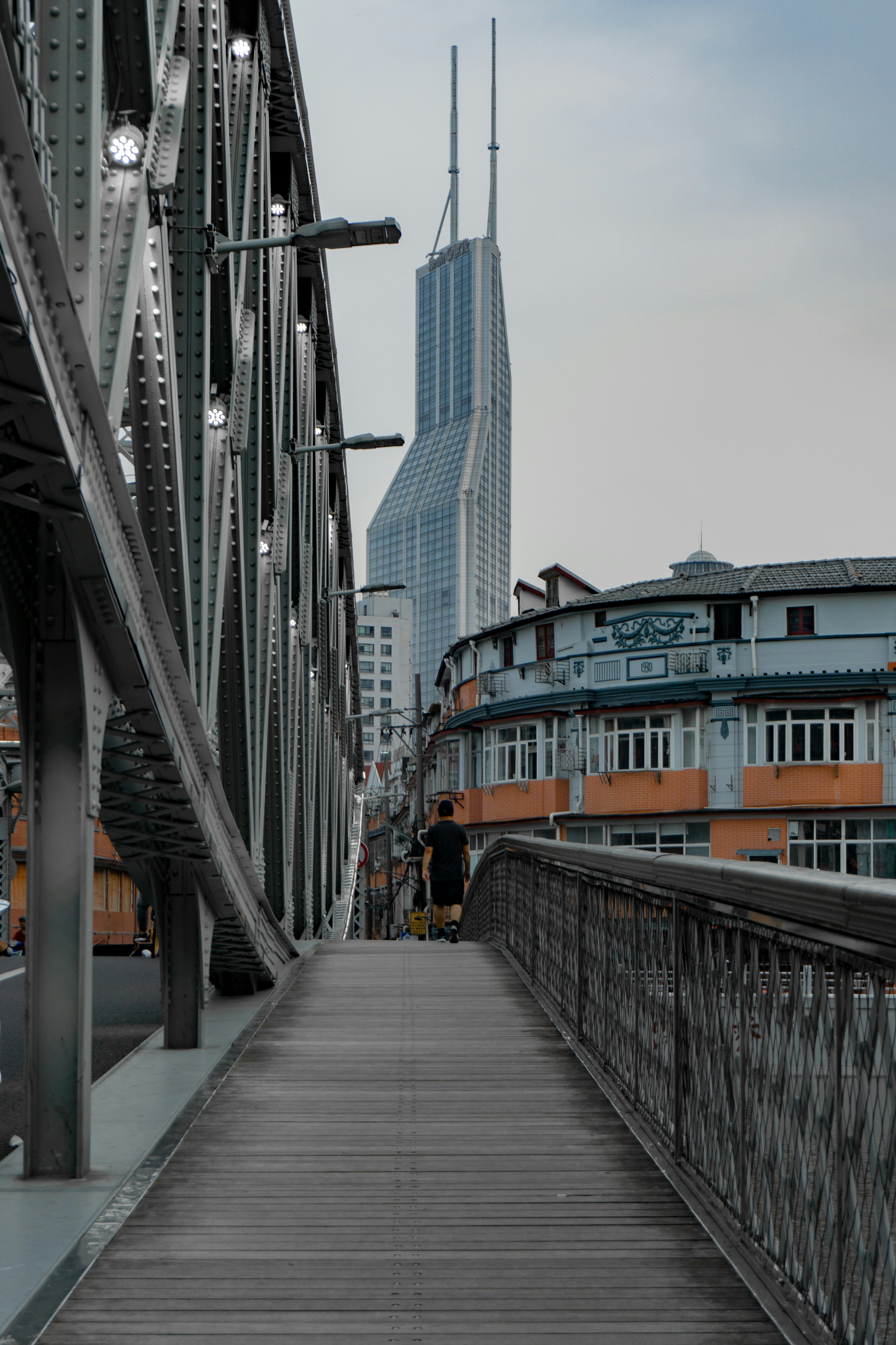 Brown wooden bridge between concrete buildings during daytime photo ...