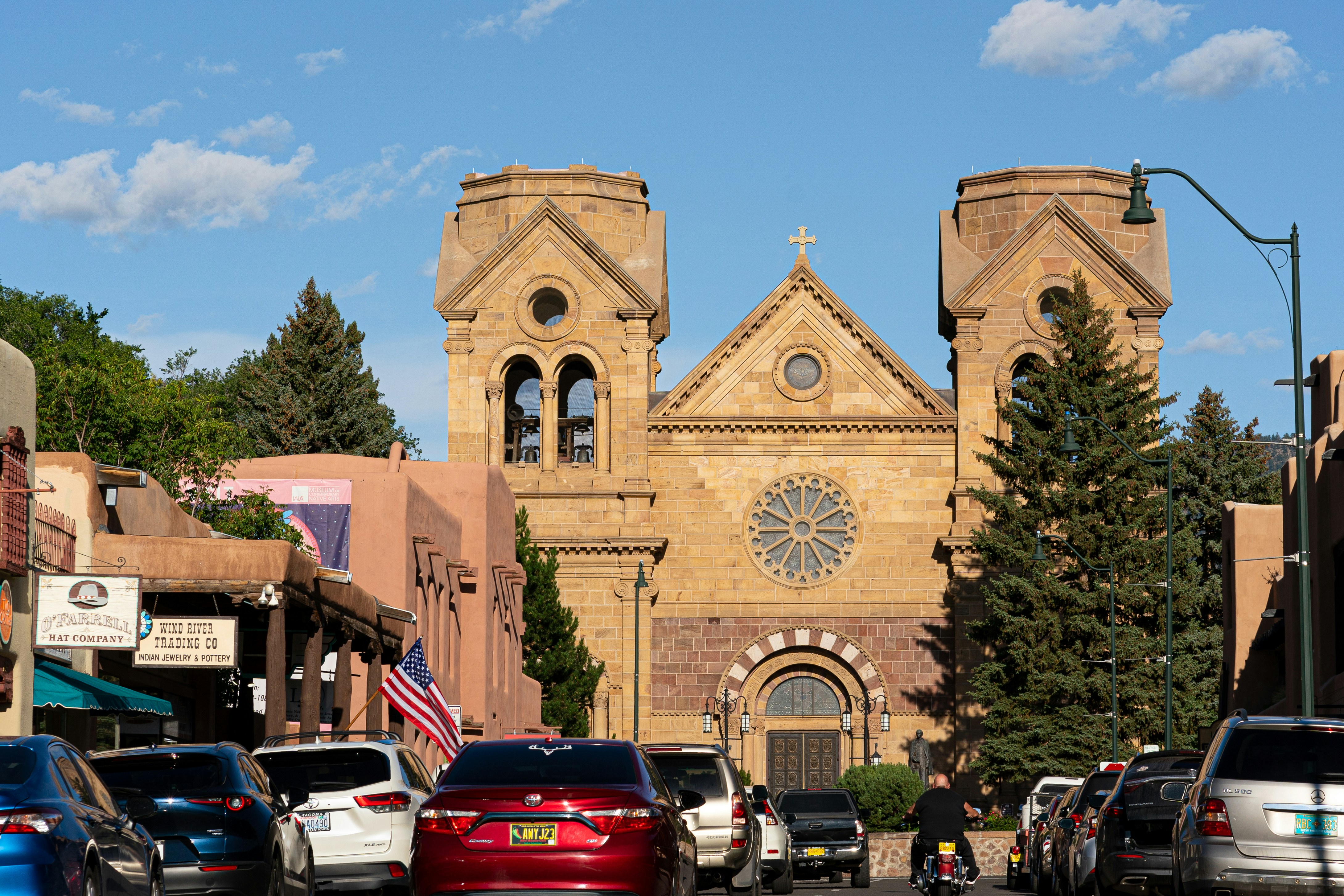 The Cathedral Basilica of St. Francis of Assisi in Santa Fe, NM | cars parked in front of brown concrete building during daytime