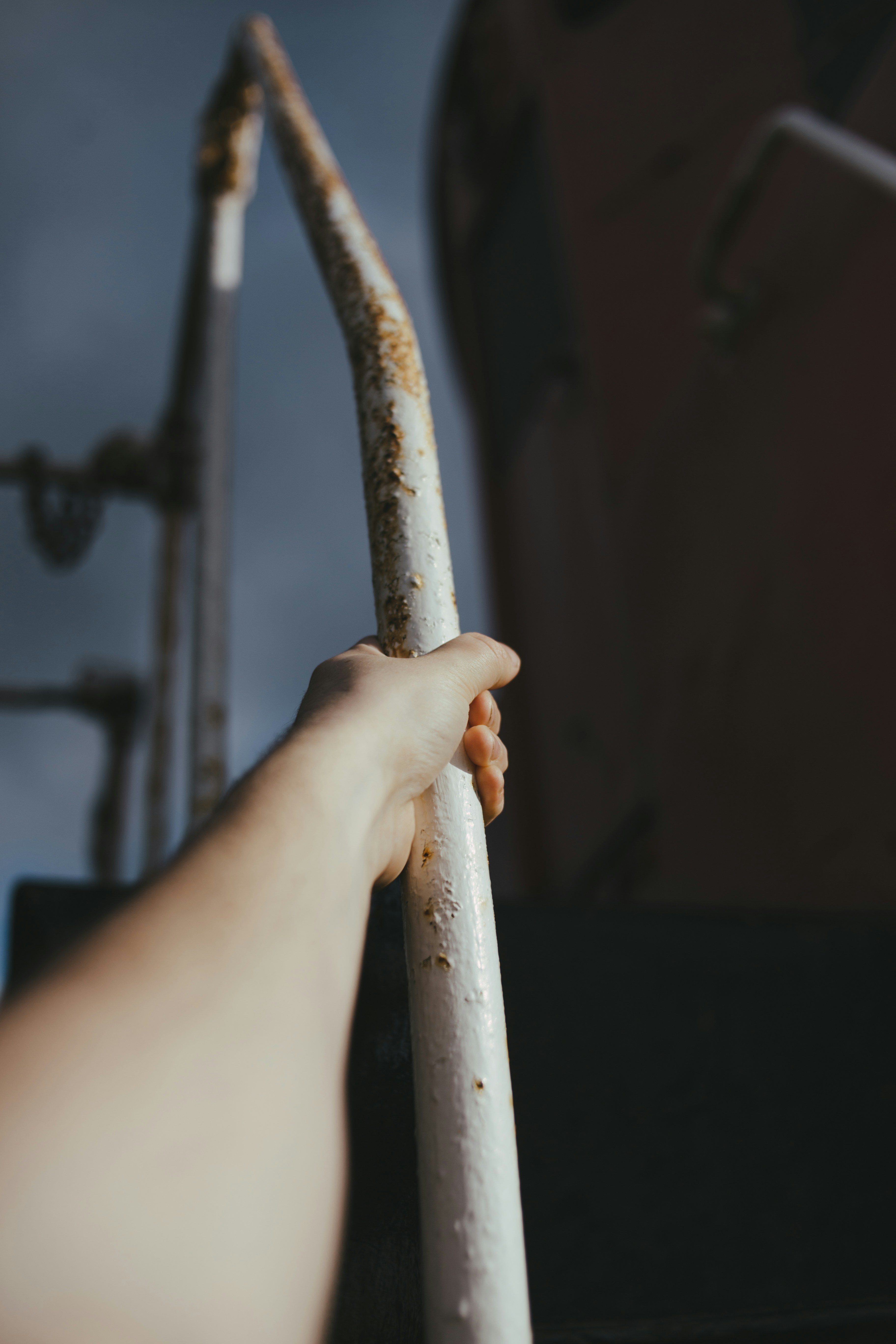 Rusted Rail Grip: A Quiet Moment of Tension on a Weathered Vessel