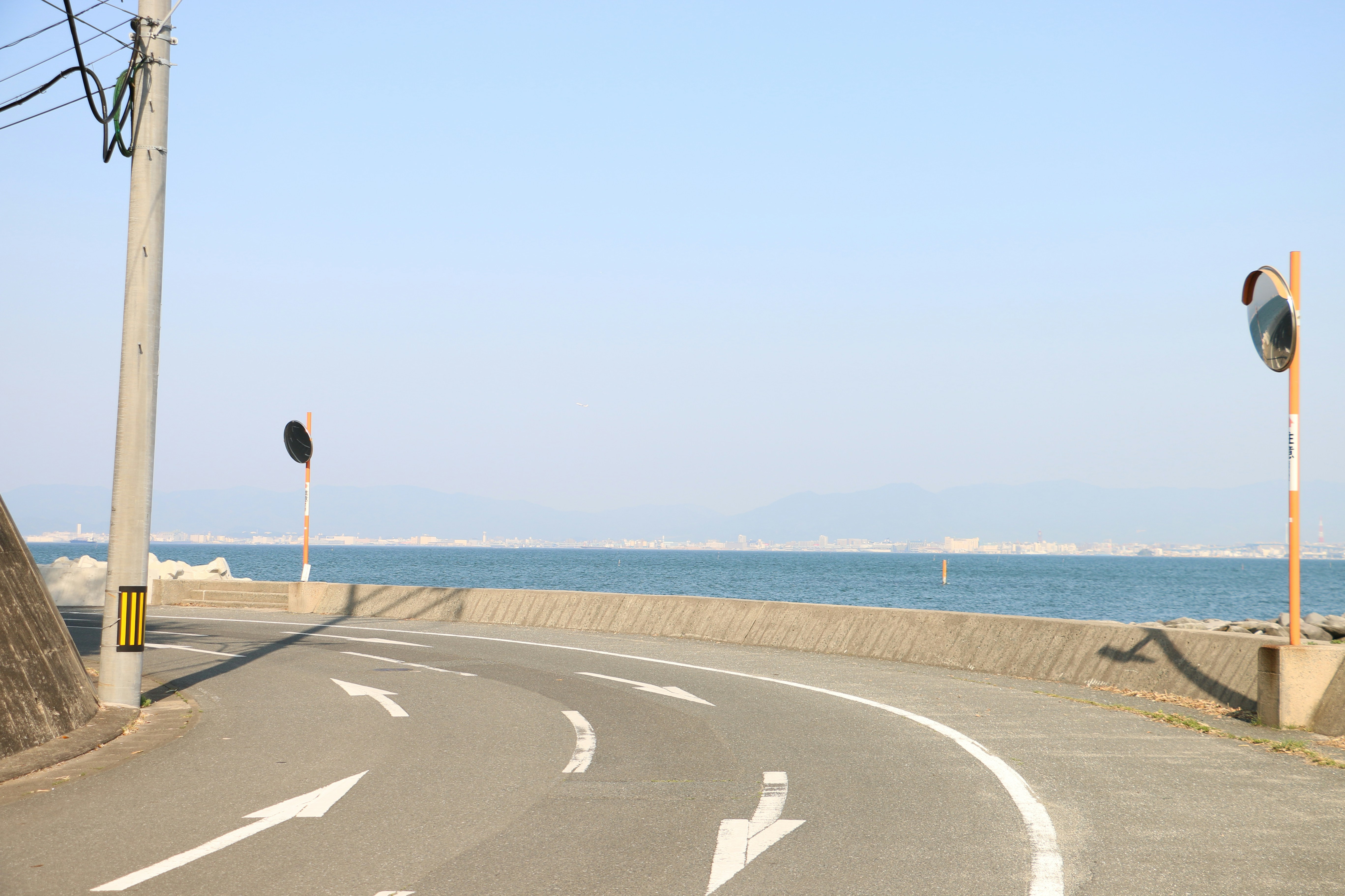 Harborbound Curve: A Quiet Seaside Road Toward the Horizon