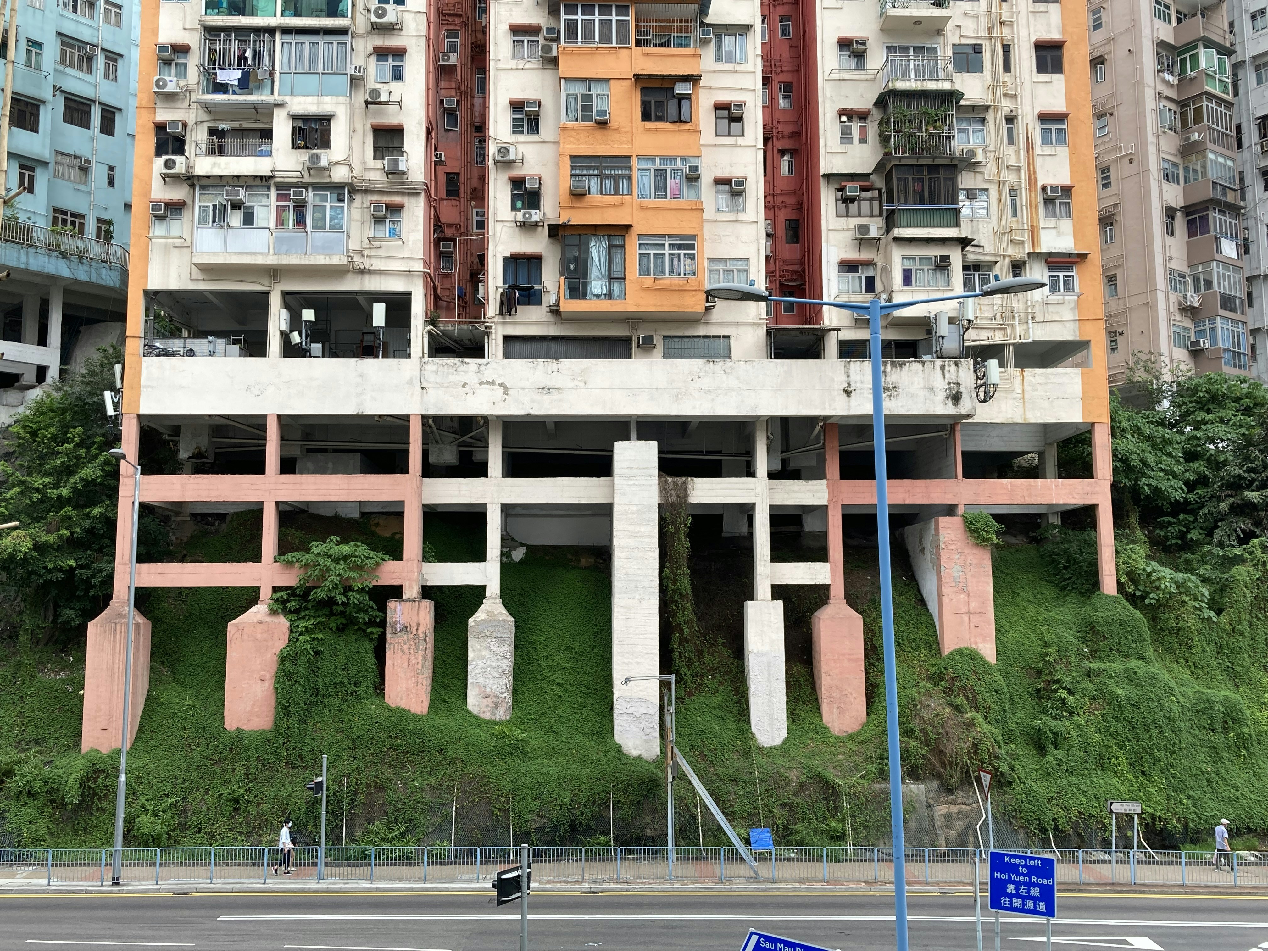 cars on road near high rise buildings during daytime