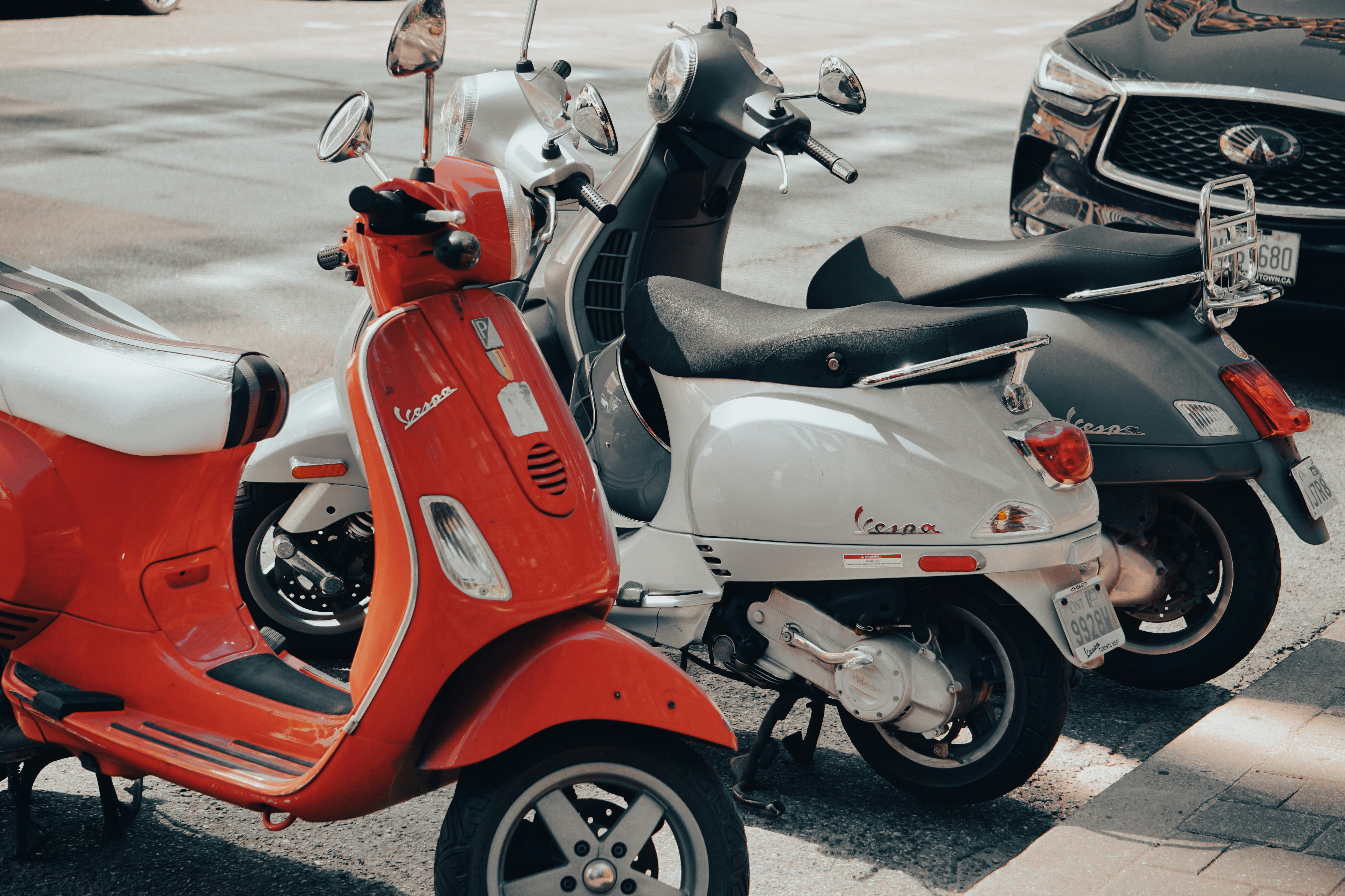 red and white motor scooter