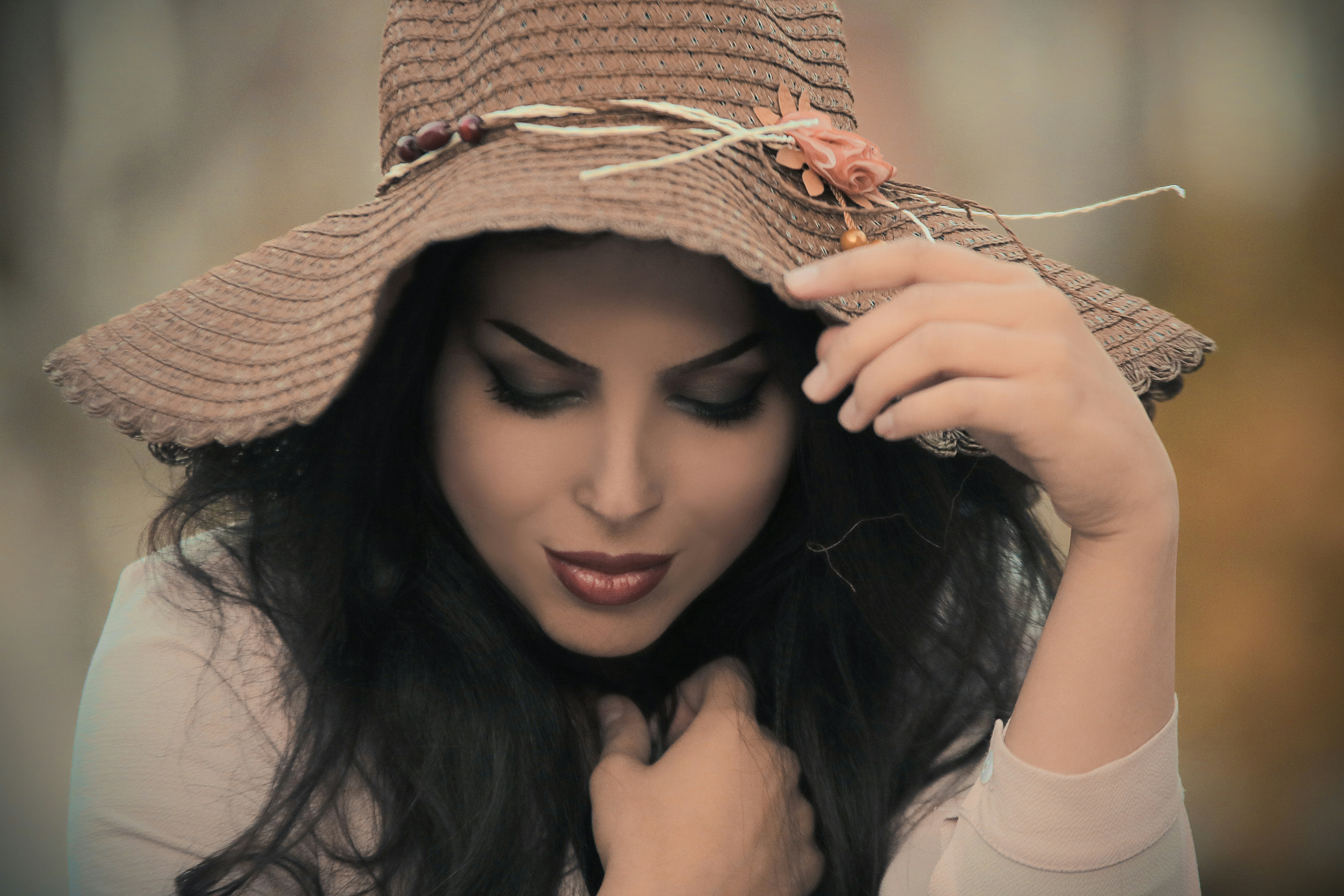 woman in white shirt wearing brown straw hat