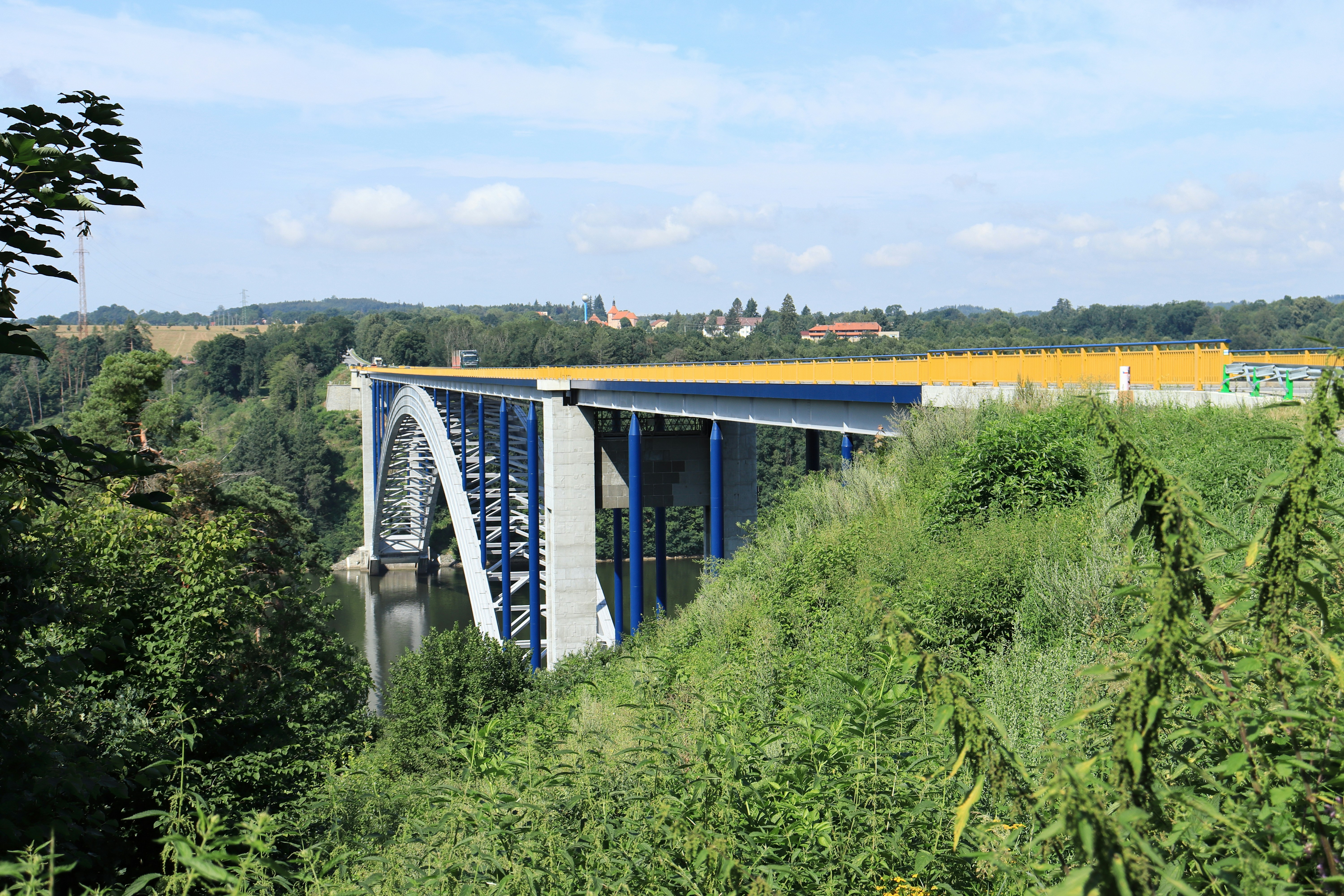 Blue Arch Bridge Cutting Through a Verdant Riverscape