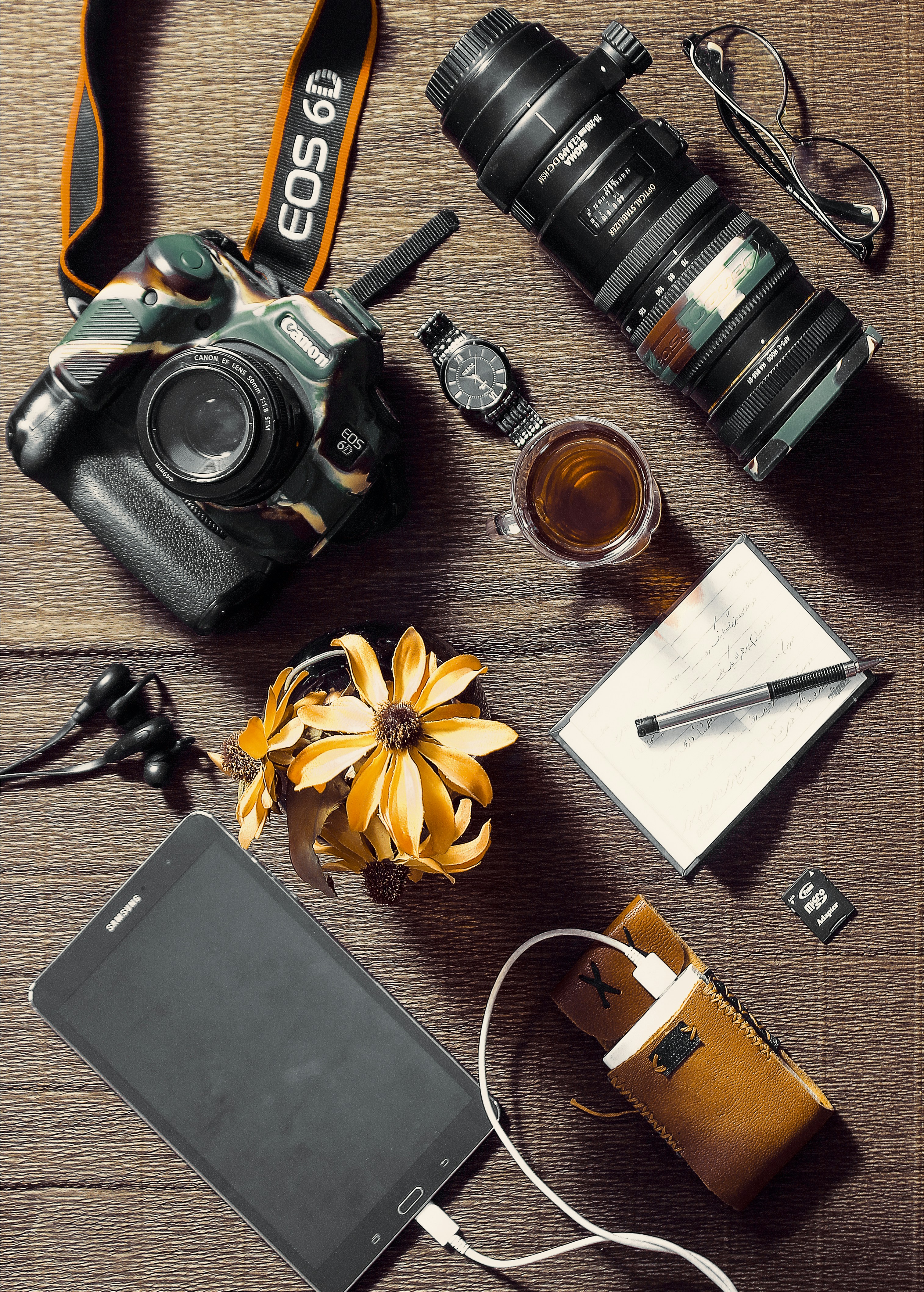 black and silver dslr camera on brown wooden table