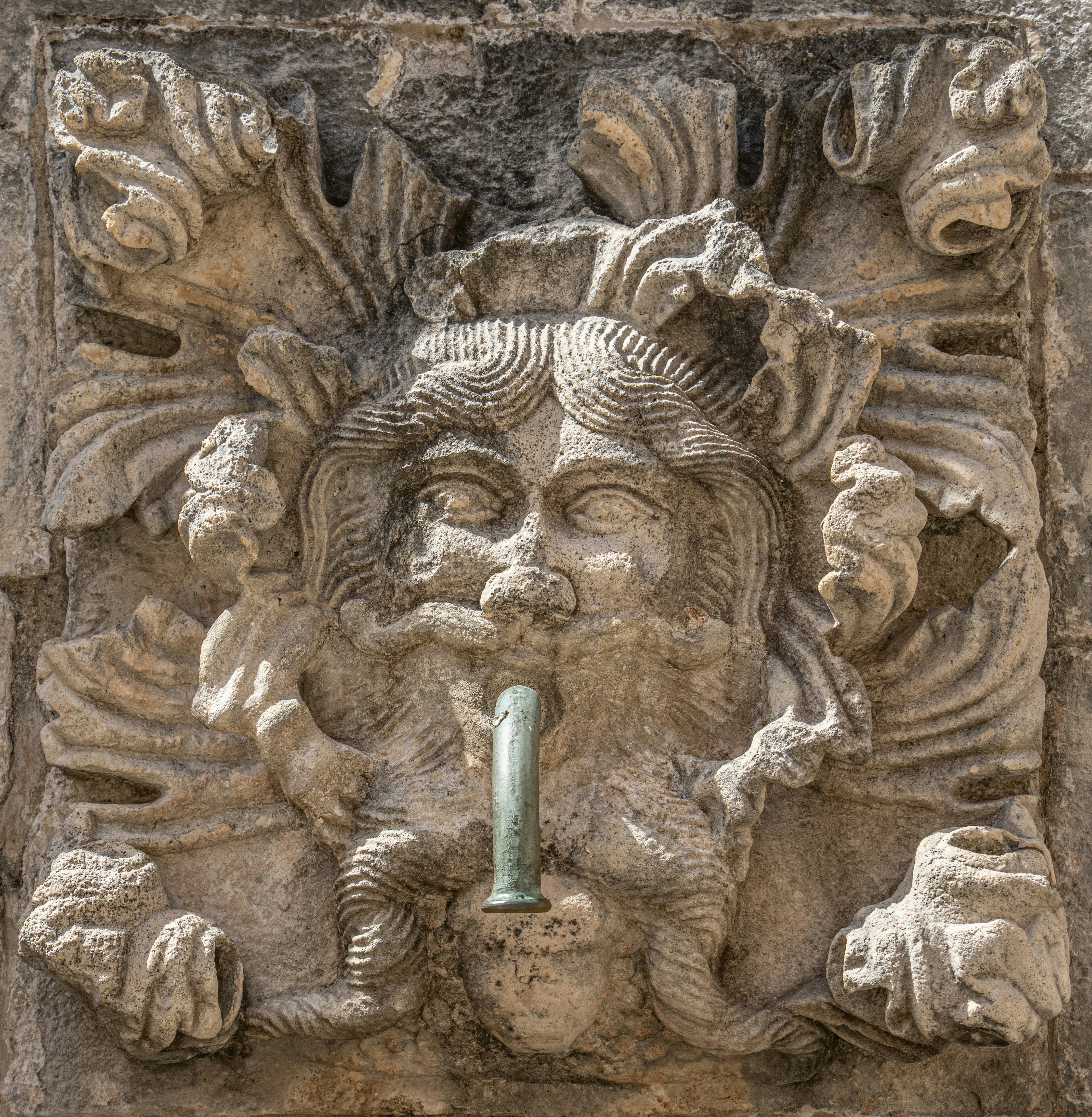 Bearded Stone Facade Fountain: Central Water Spout in an Ornate Carved Panel