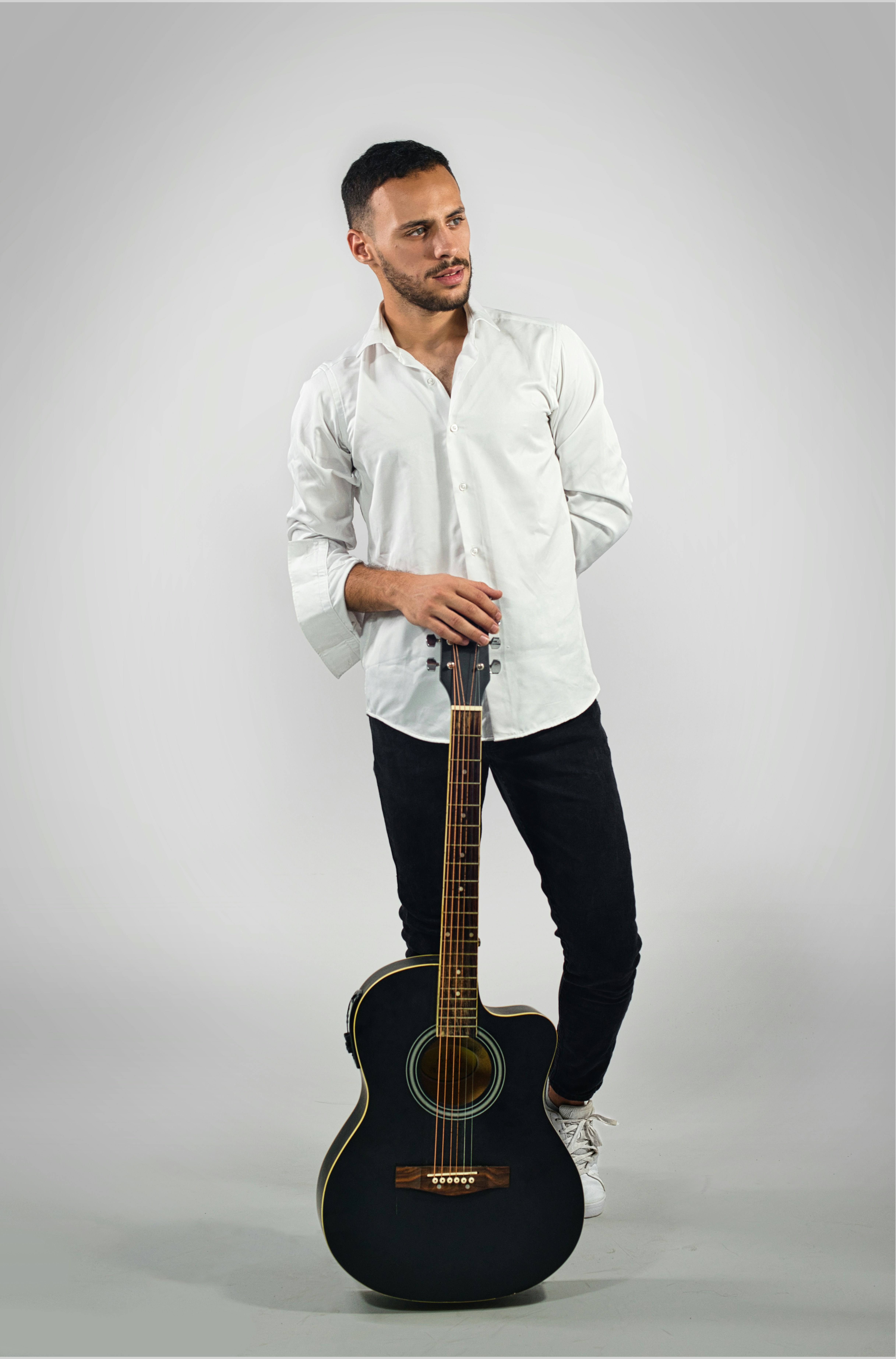 Guitarist in White Shirt: Quiet Confidence with an Acoustic Pendant