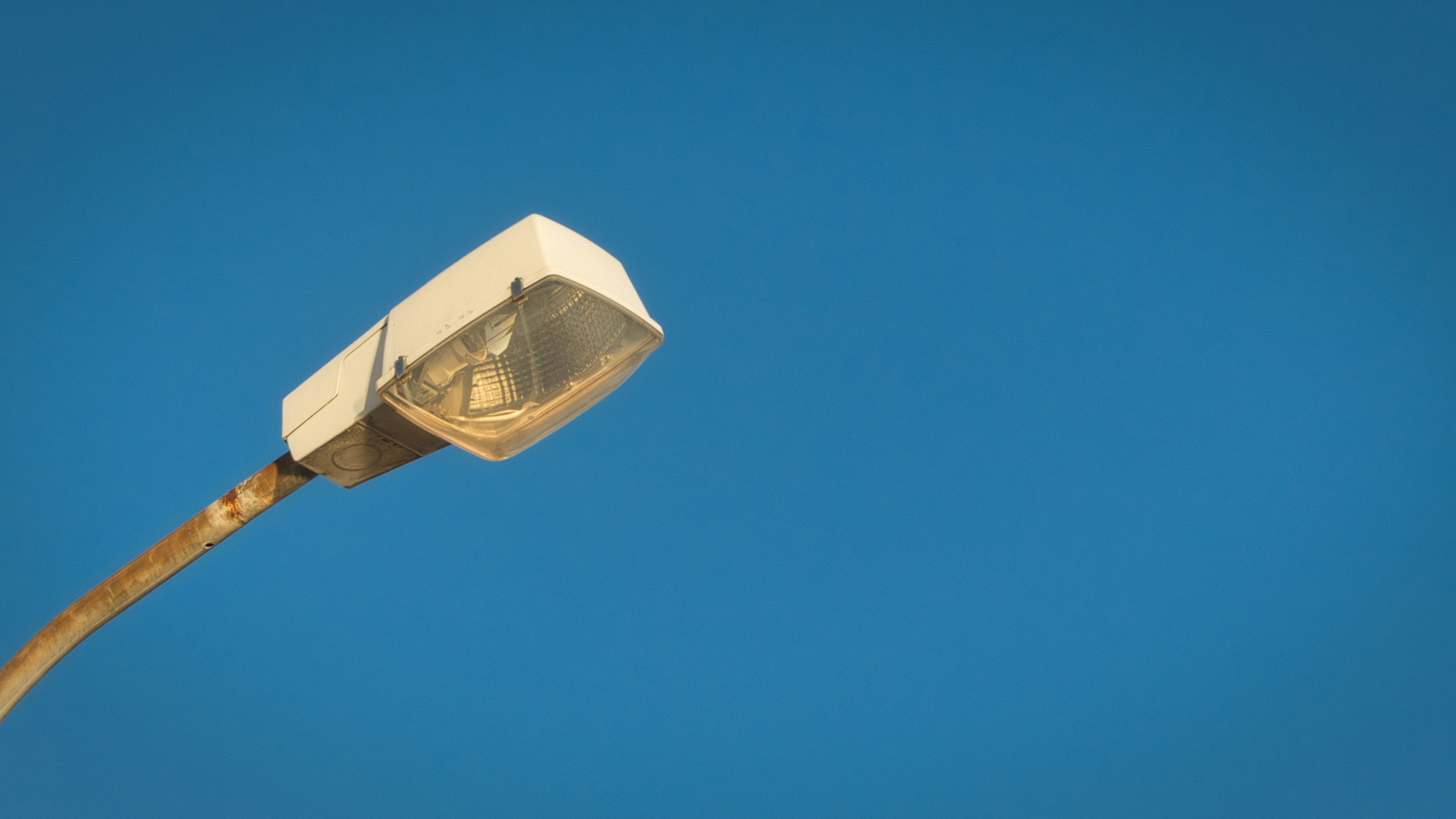 Minimalist Street Lamp Reaching Toward a Clear Sky