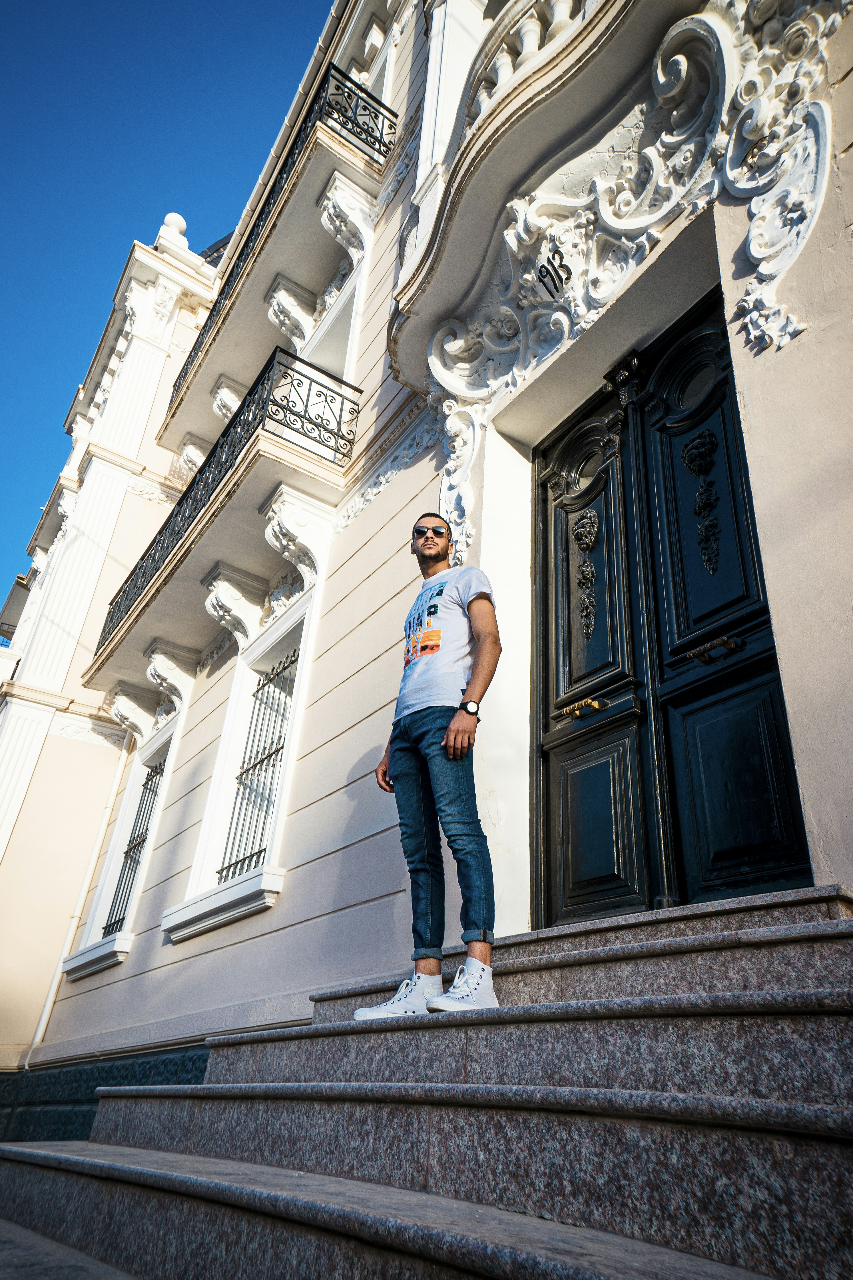 Urban Portrait on Marble Steps Under Ornate Facade