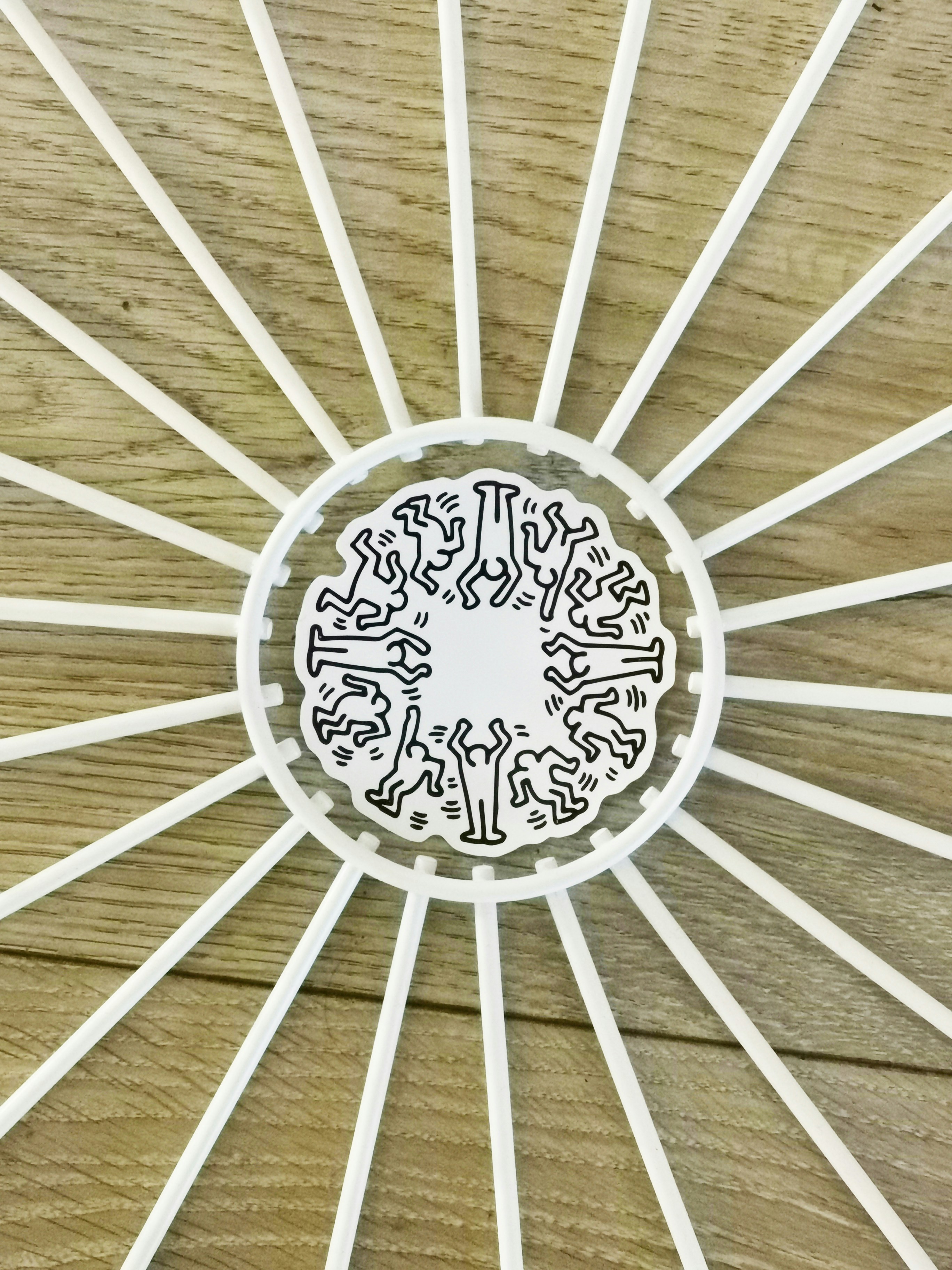 Hub in Focus: White Spoked Wheel on Wood