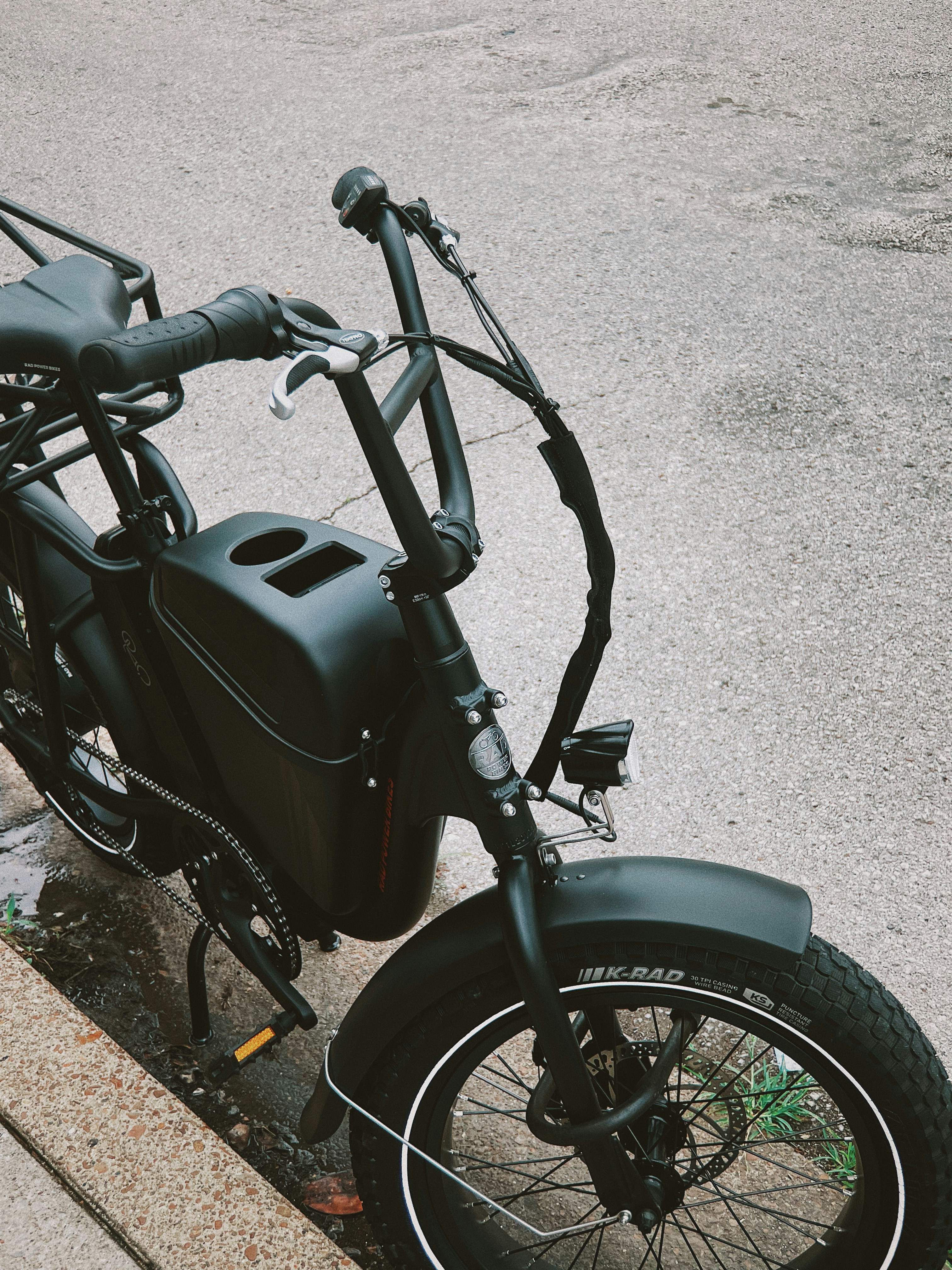 Midnight Commuter: A Matte-Black Electric Bike Rests by the Curb