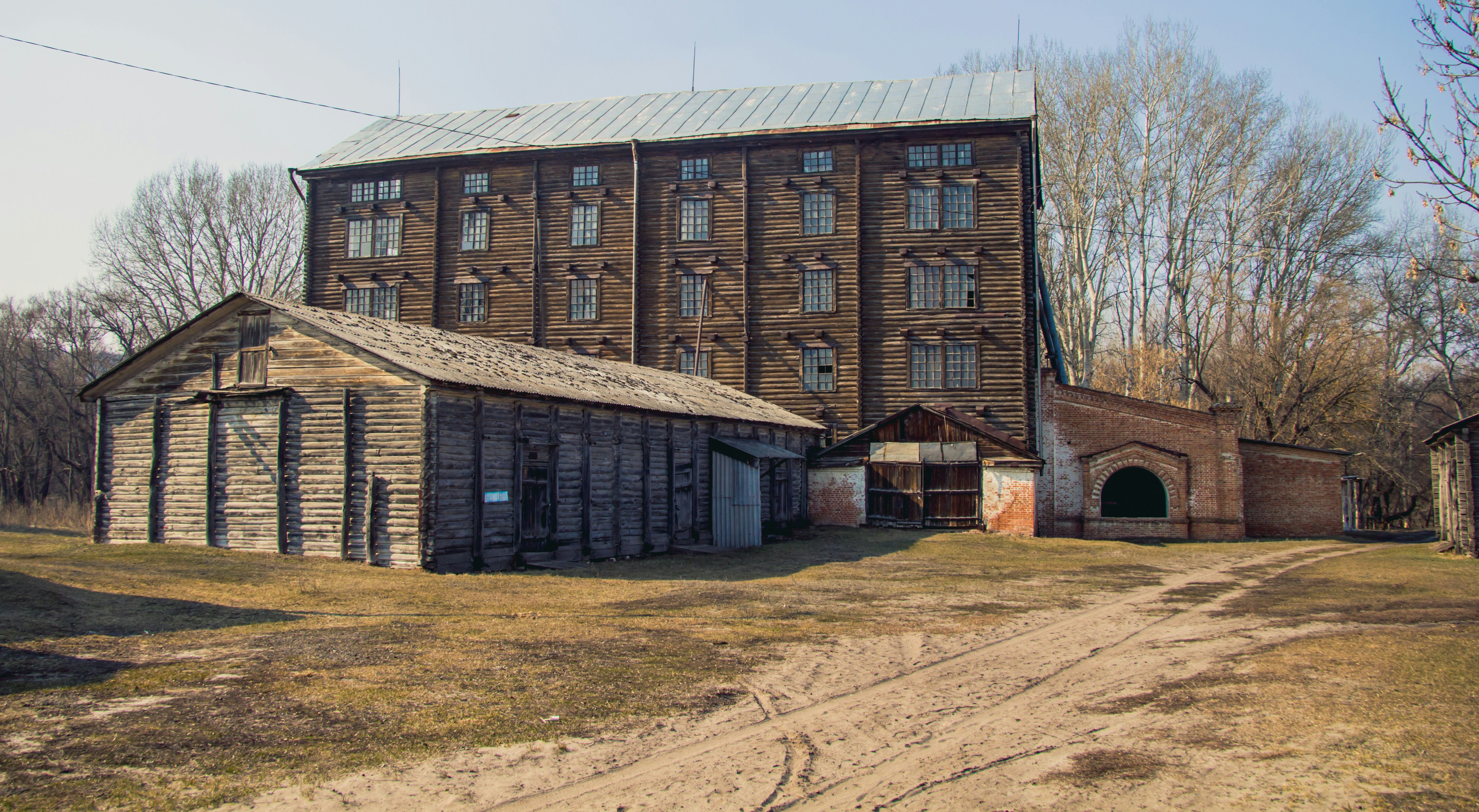brown brick building near bare trees during daytime