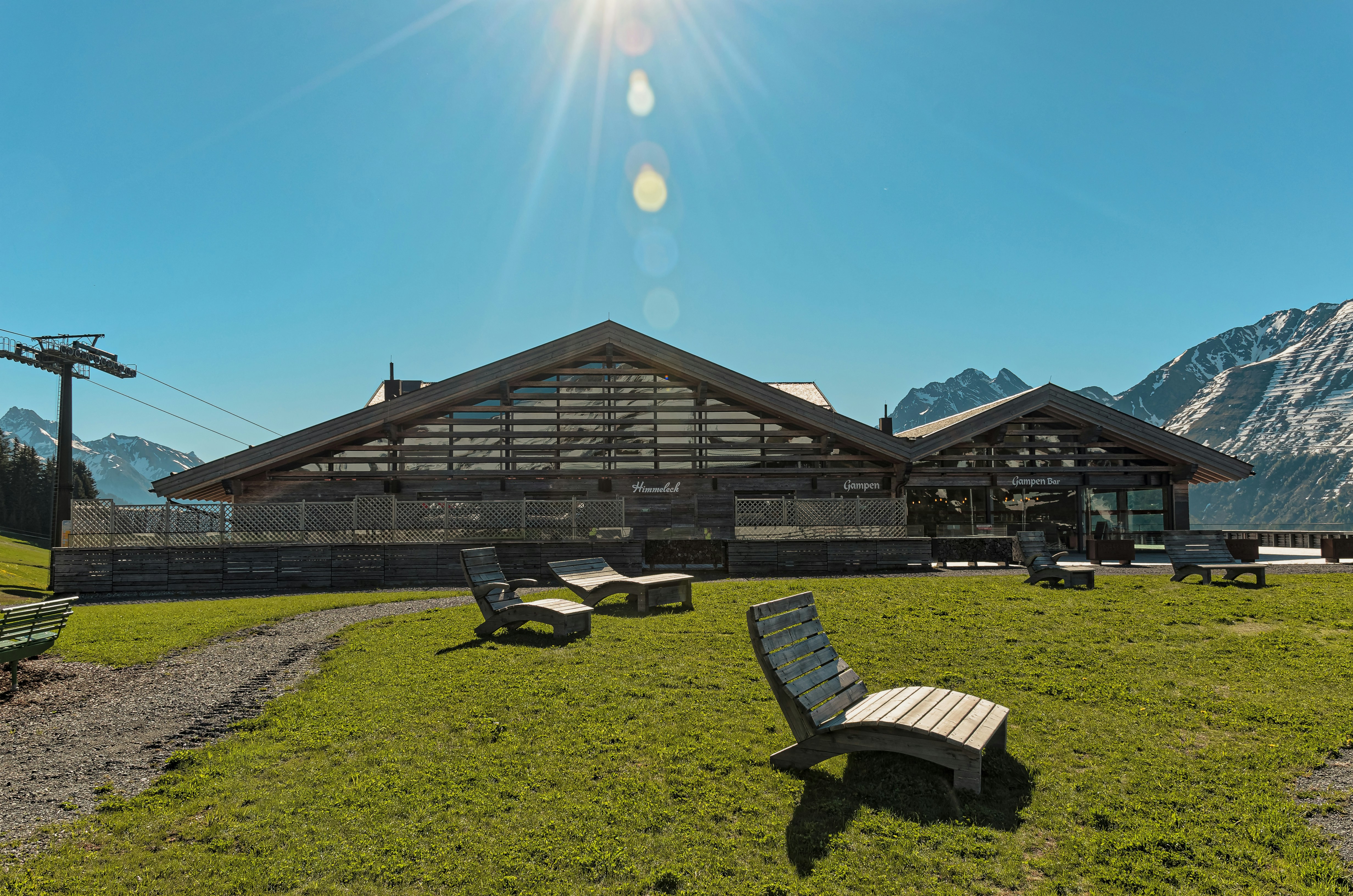 Sunny Alpine Lodge Before the Glow: A Tranquil Terrace by the Mountain Range