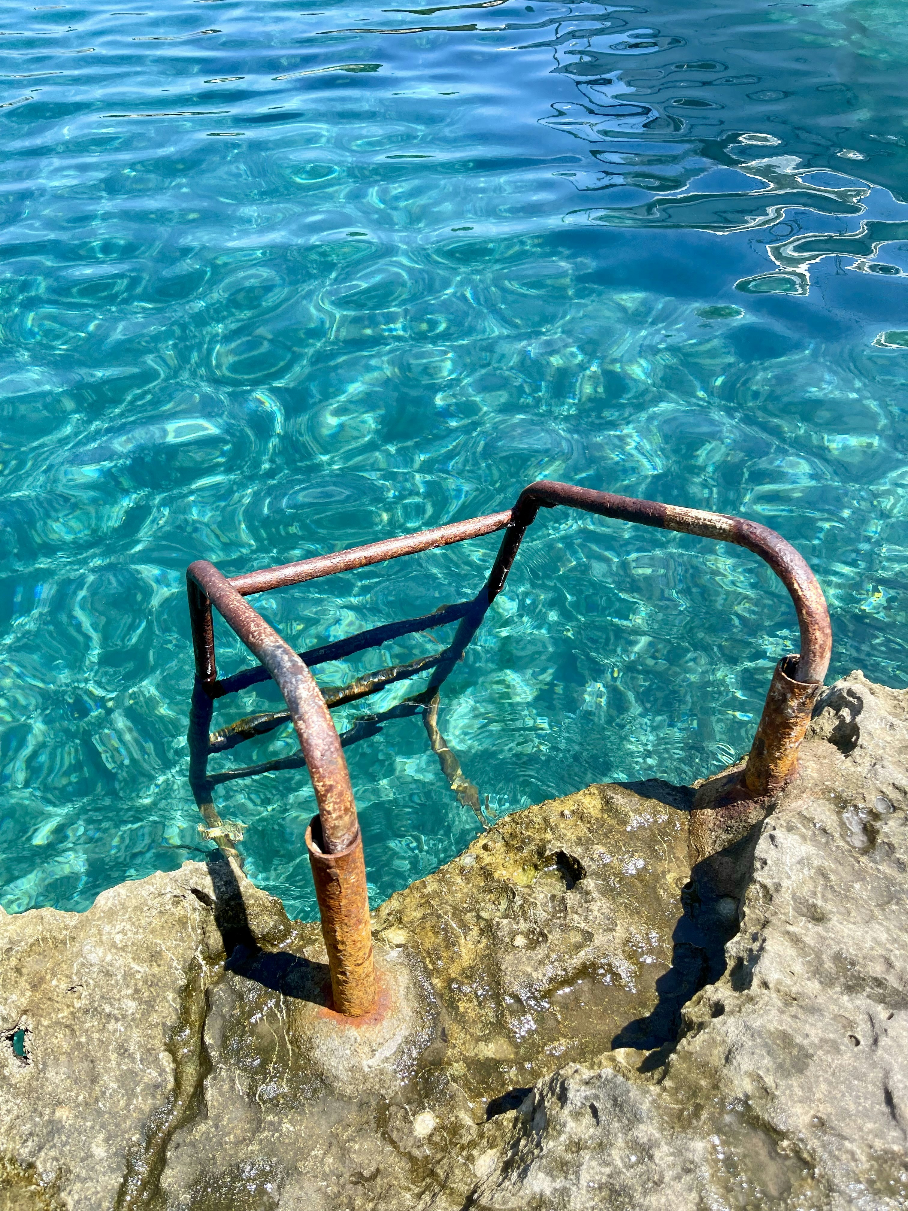 Rusted Ladder at the Edge of Turquoise Depths