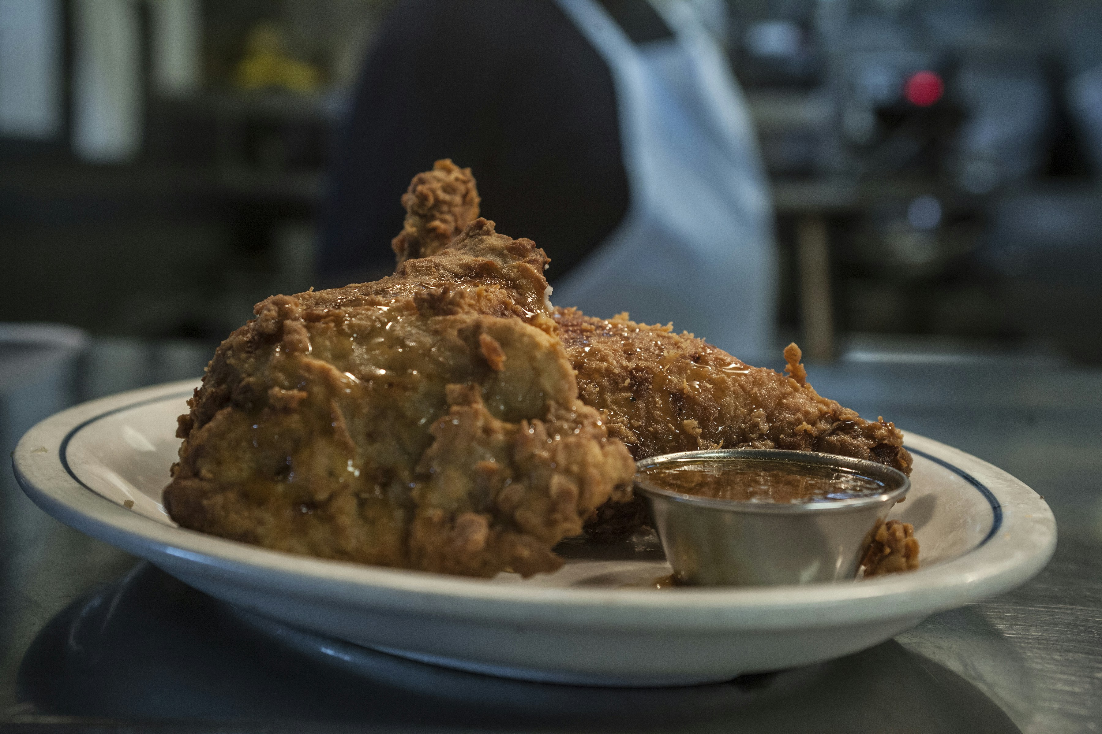 Crispy Fried Poultry with Sauce: A Plate in a Busy Kitchen