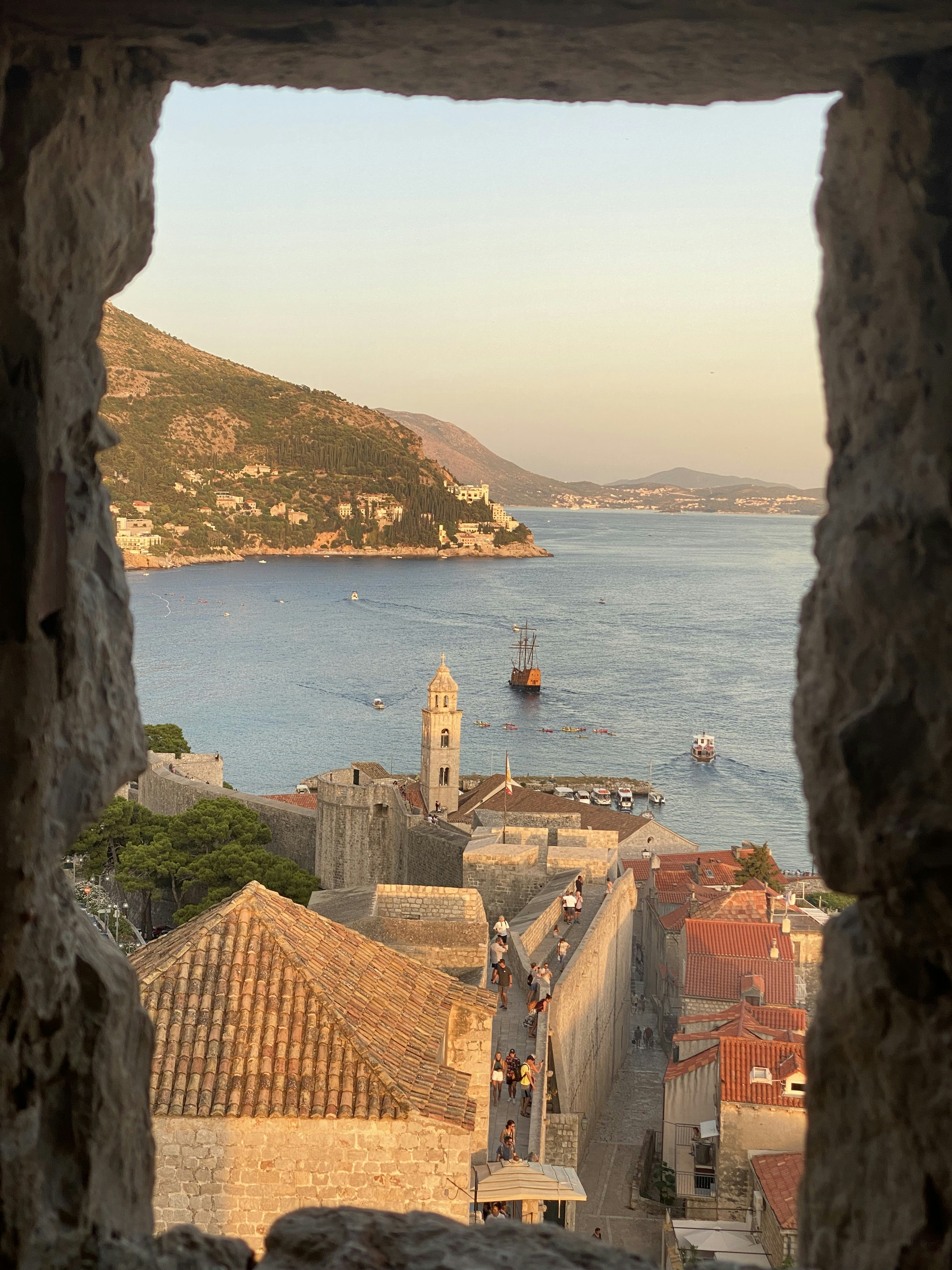 Brown concrete building near body of water during daytime photo – Free ...