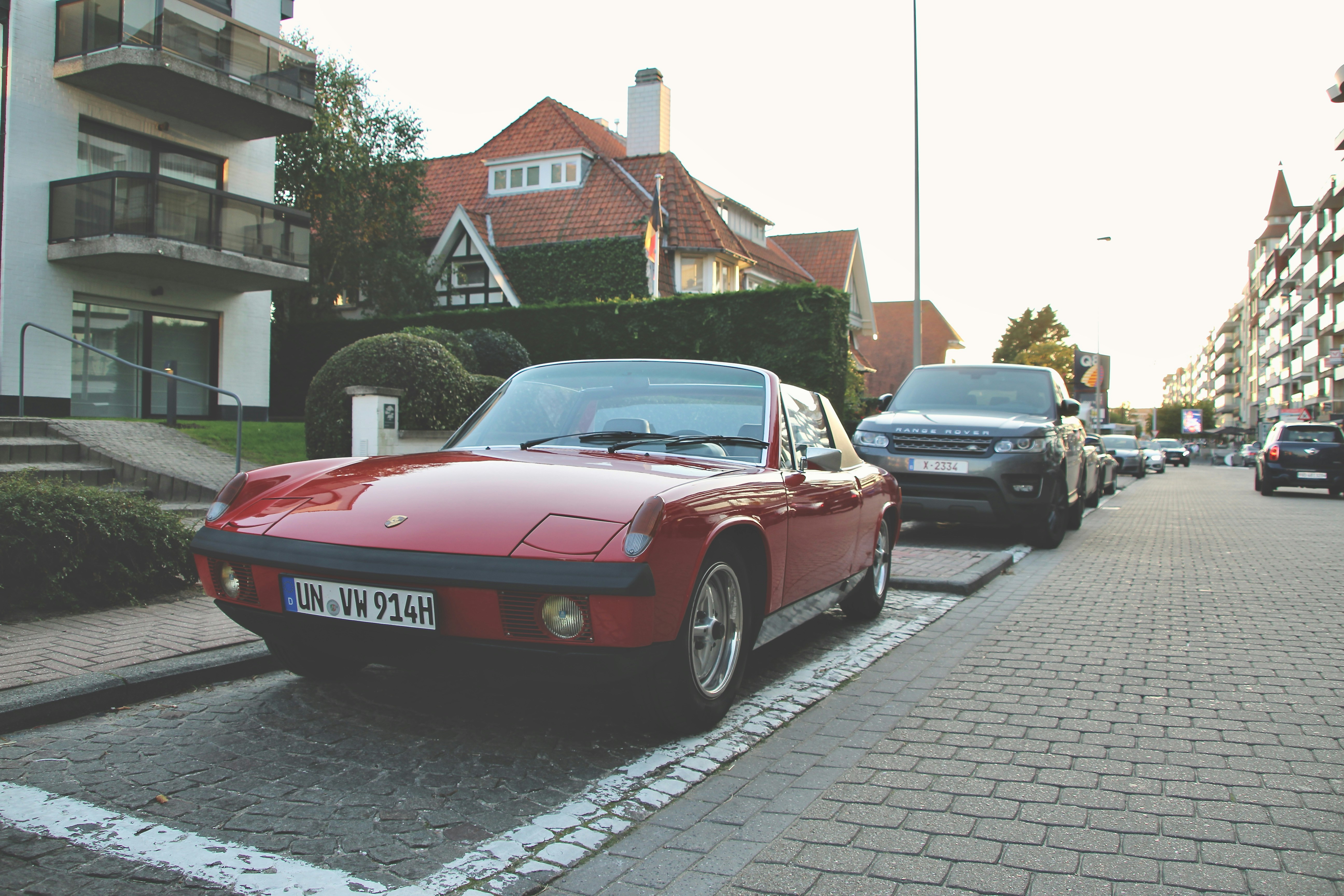 Crimson Porsche on a Quiet European Cobblestone Street