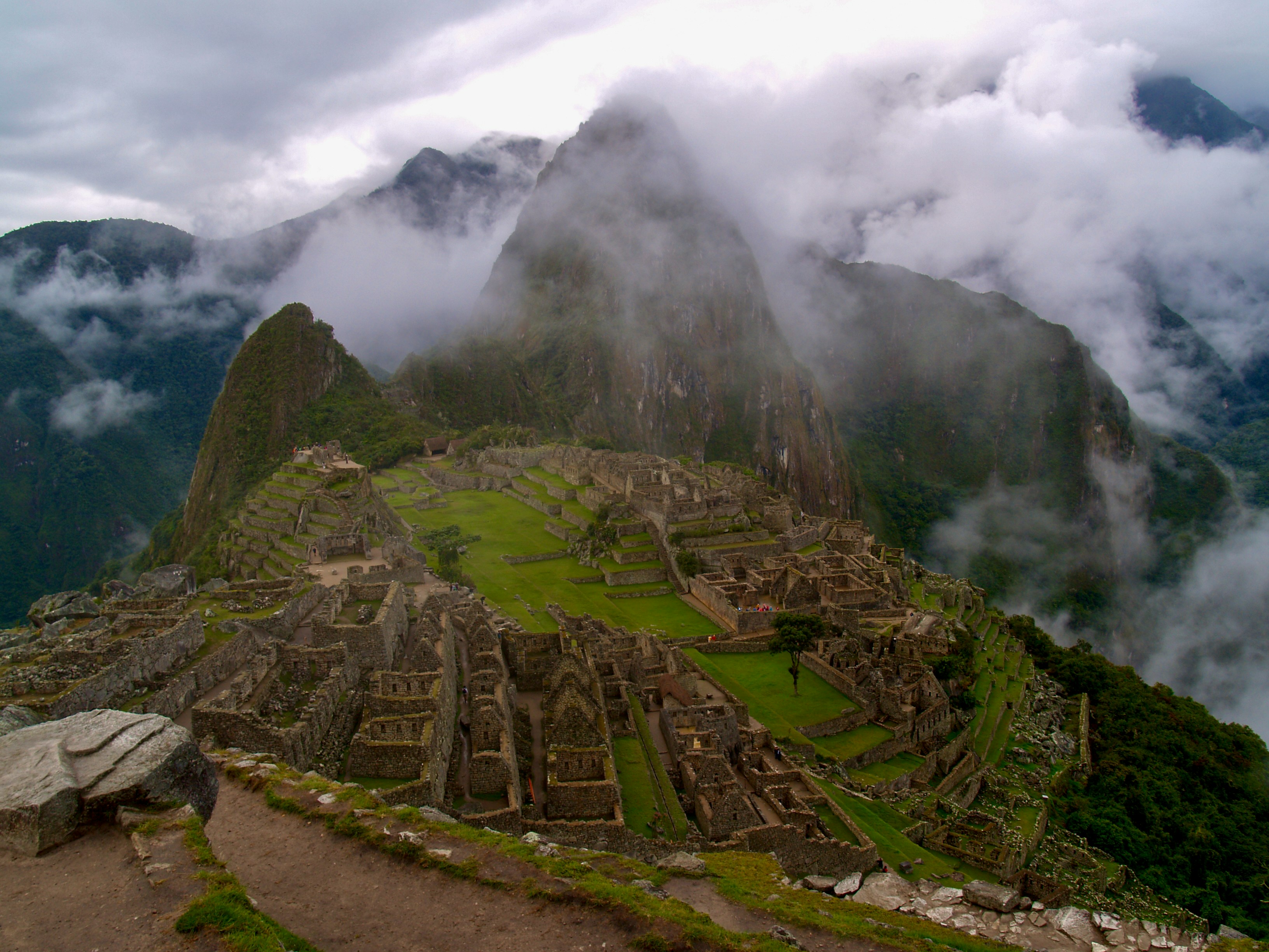 Machu Picchu surrounded by misty mountains and drifting clouds.