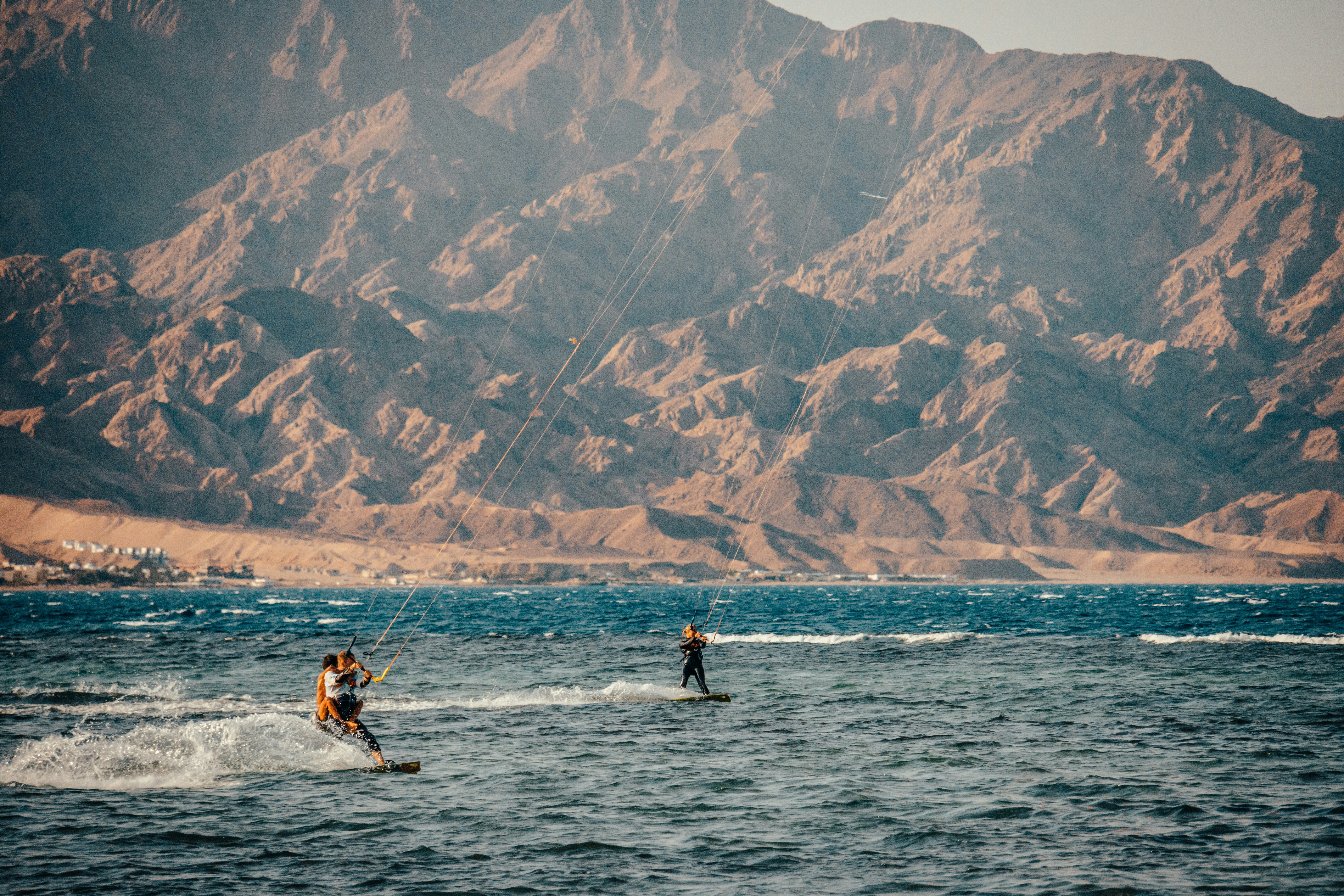 2 people surfing on sea during daytime photo – Free Dahab Image on Unsplash