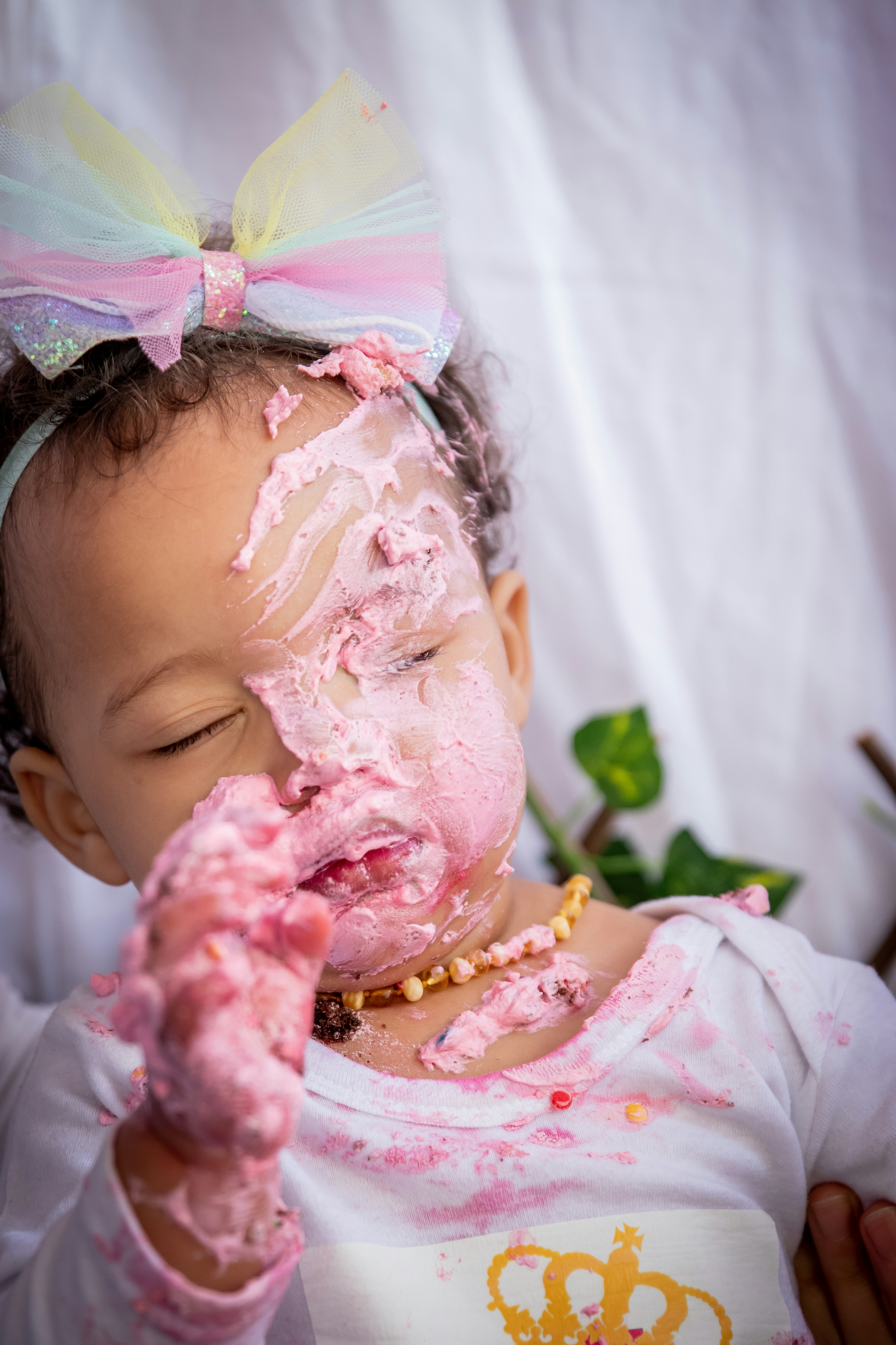 Soft Chaos: A Baby with Pink Frost and Rainbow Bow