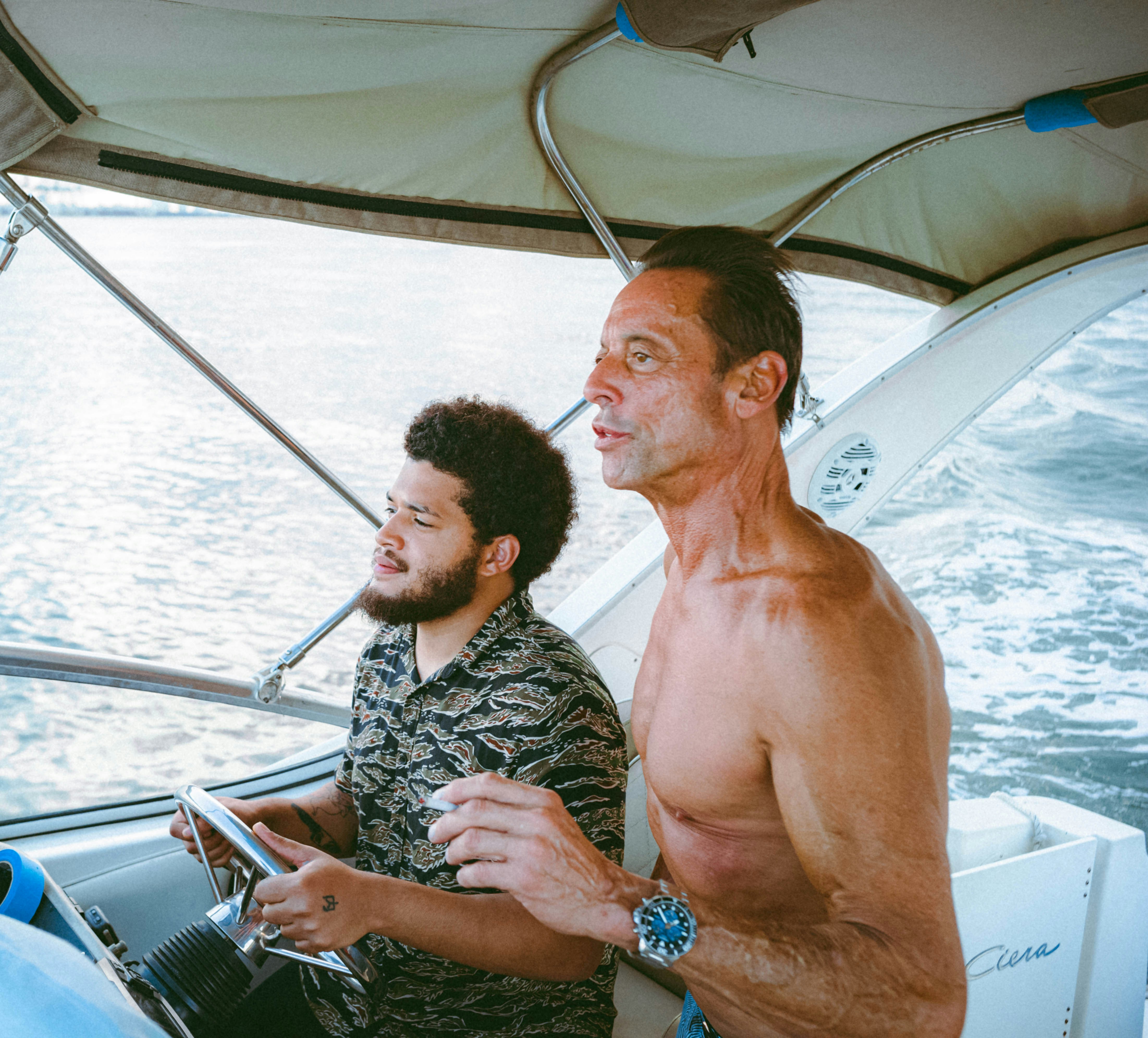 On Deck: A Duo at the Helm under Open Sea Skies