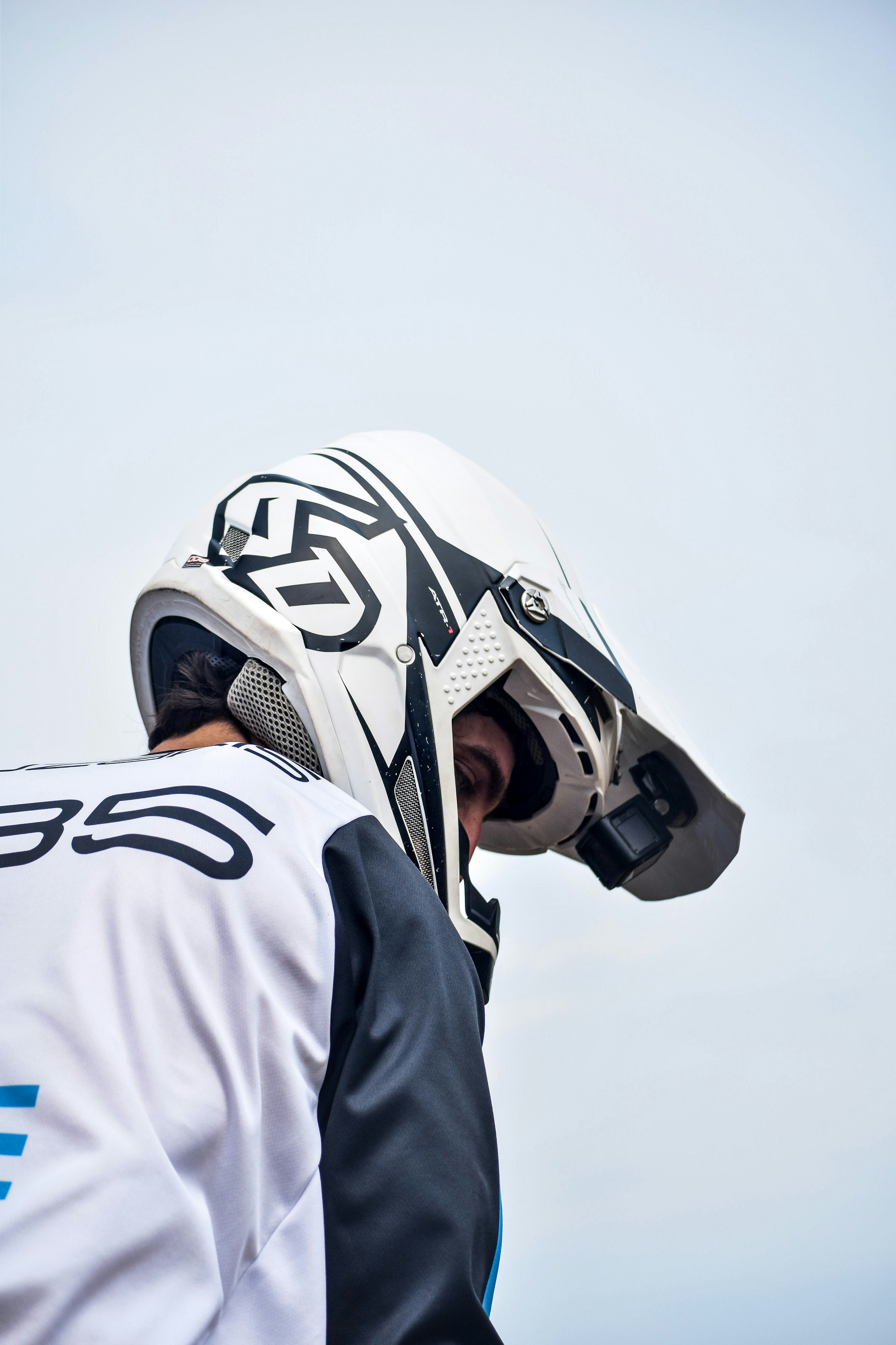Helmeted Athlete Gaze: Close-Cropped Focus on the Racer’s Helmet and Shoulder